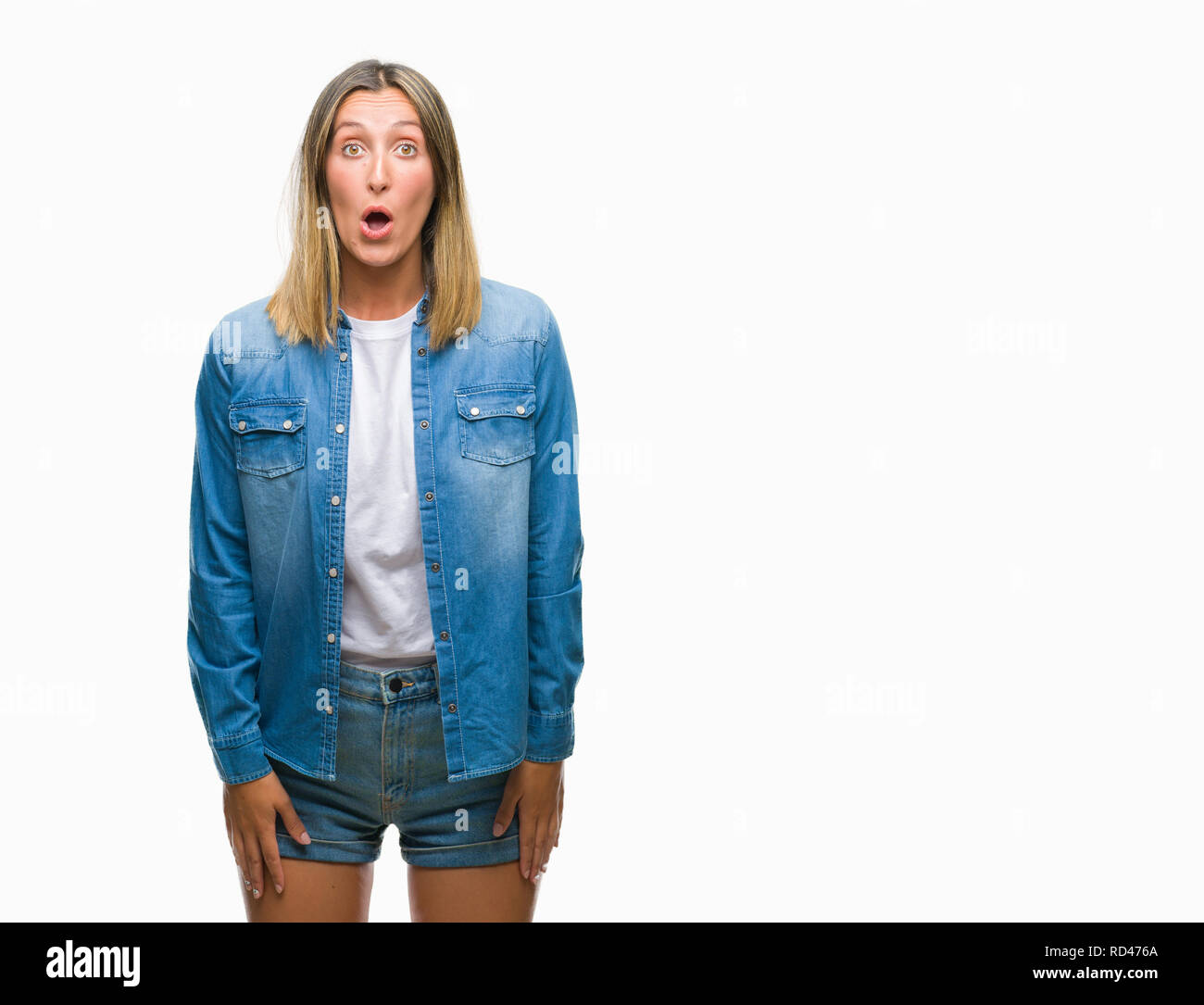 Young beautiful woman over isolated background afraid and shocked with ...