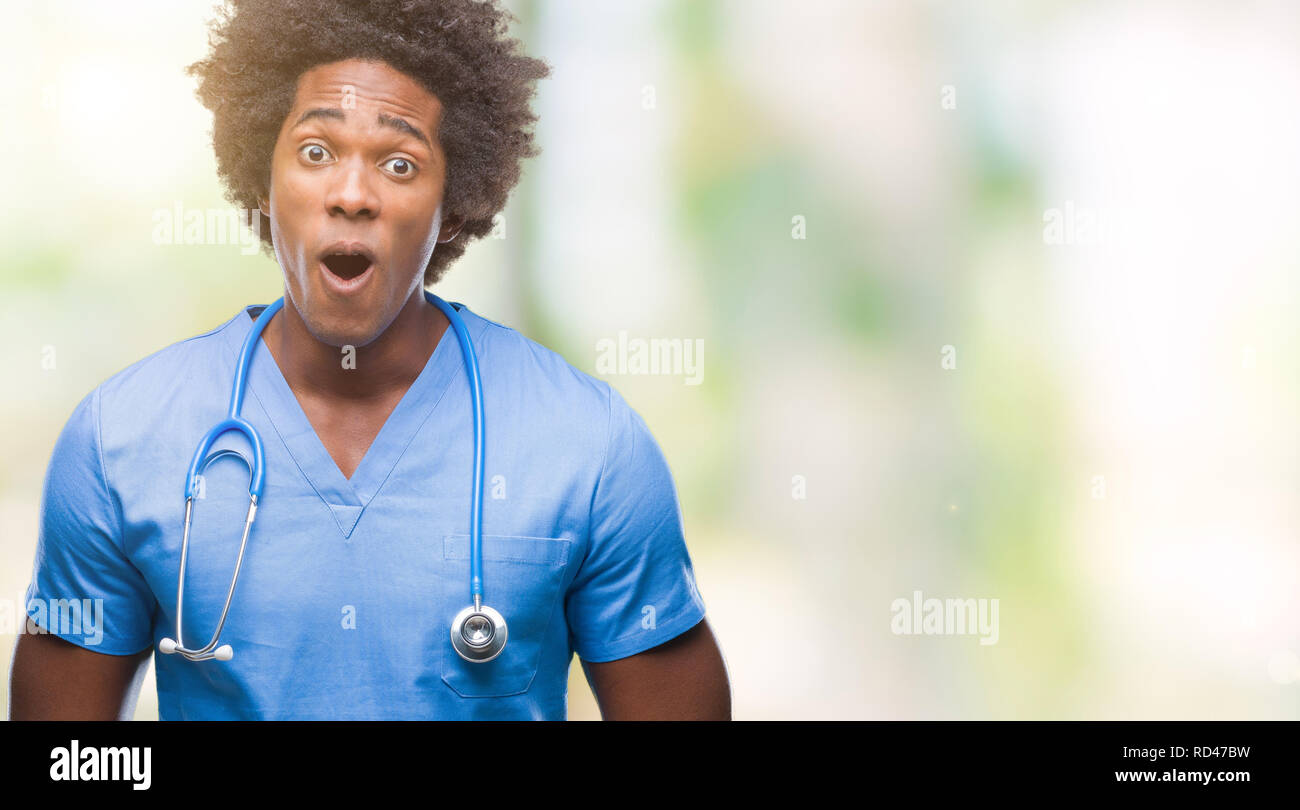 Afro american surgeon doctor man over isolated background afraid and ...