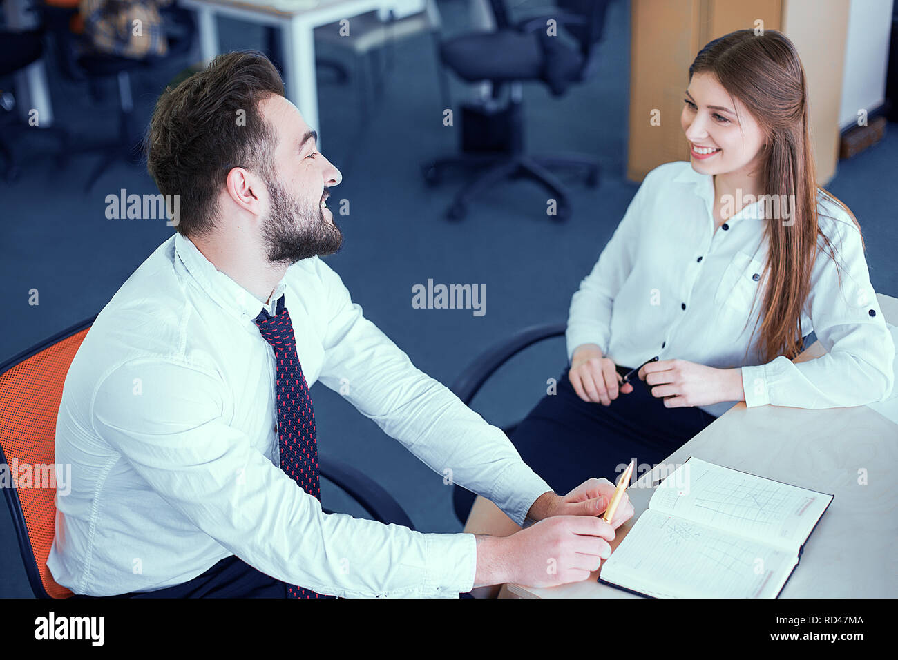 A couple of colleagues at the desk Stock Photo - Alamy