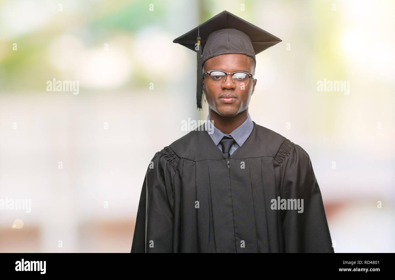 Young graduated african american man over isolated background with ...