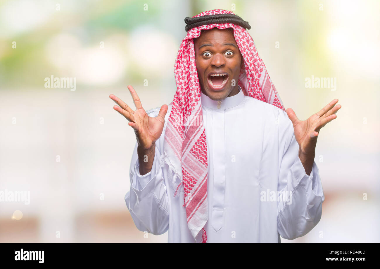 Young arabic african man wearing traditional keffiyeh over isolated ...