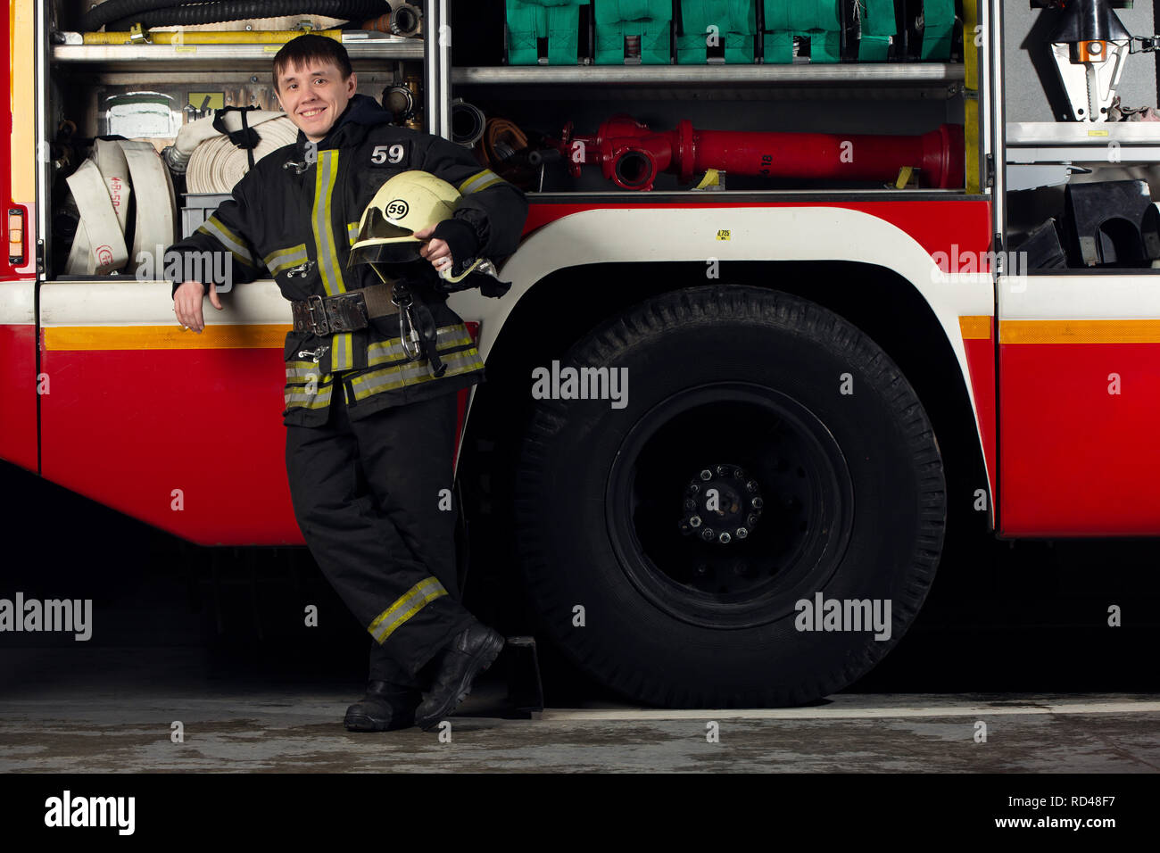 Picture of young fireman man near fire truck Stock Photo - Alamy