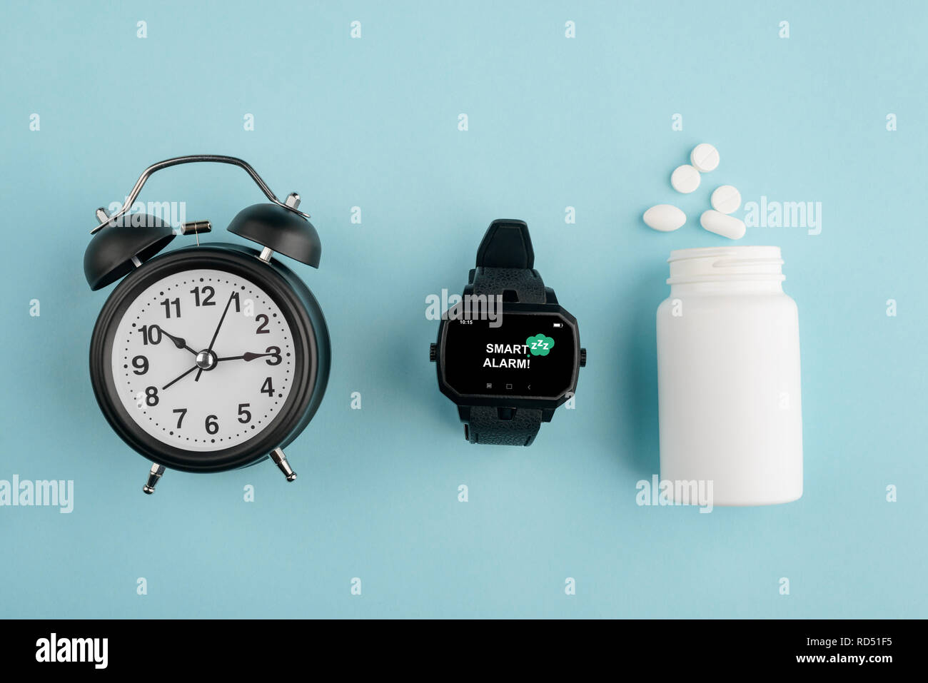 Alarm clock, watch and pills Stock Photo - Alamy