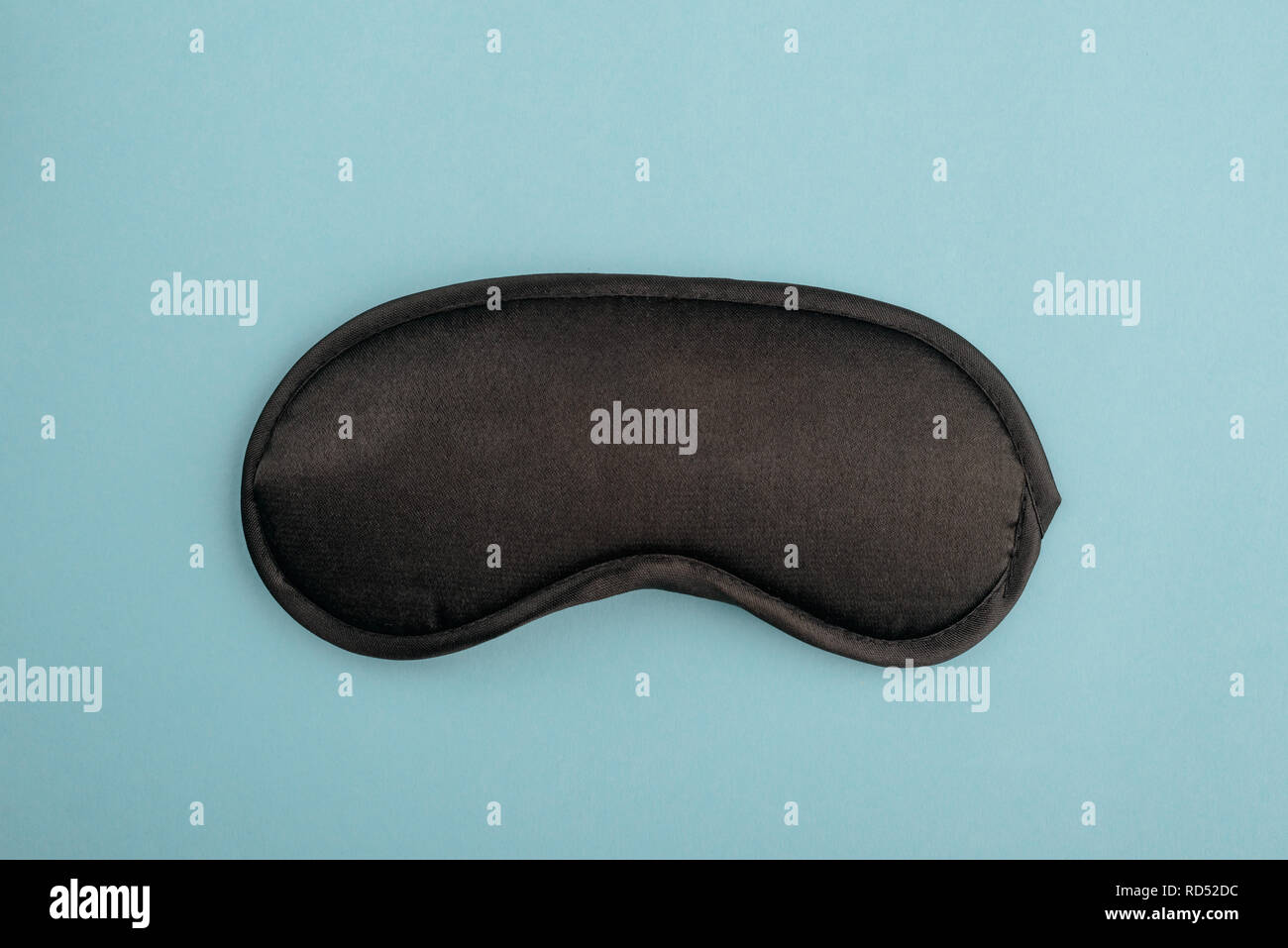 Black eye mask on blue Stock Photo - Alamy