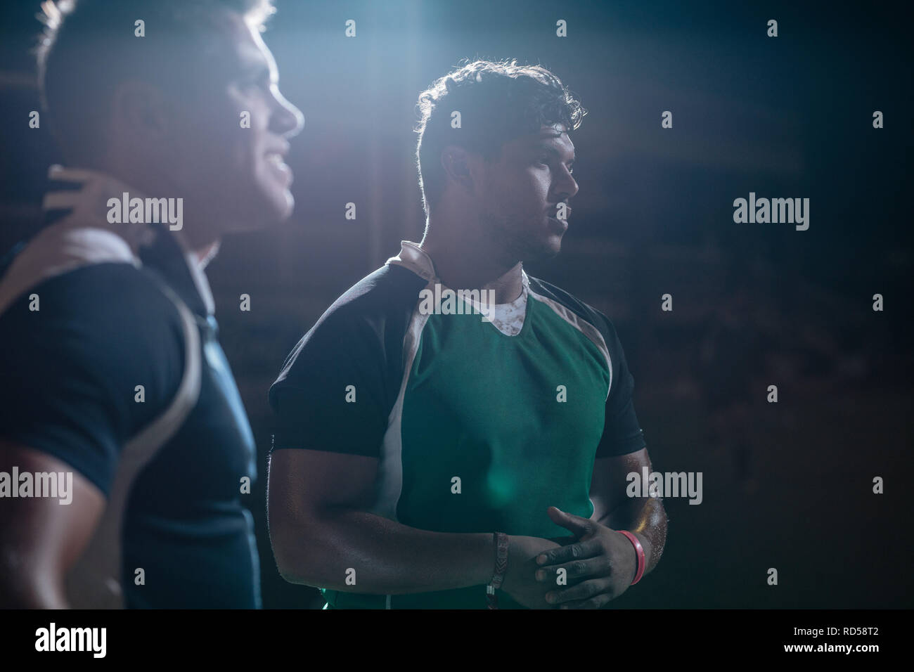rugby players standing in stadium during night game. Opposite rugby ...