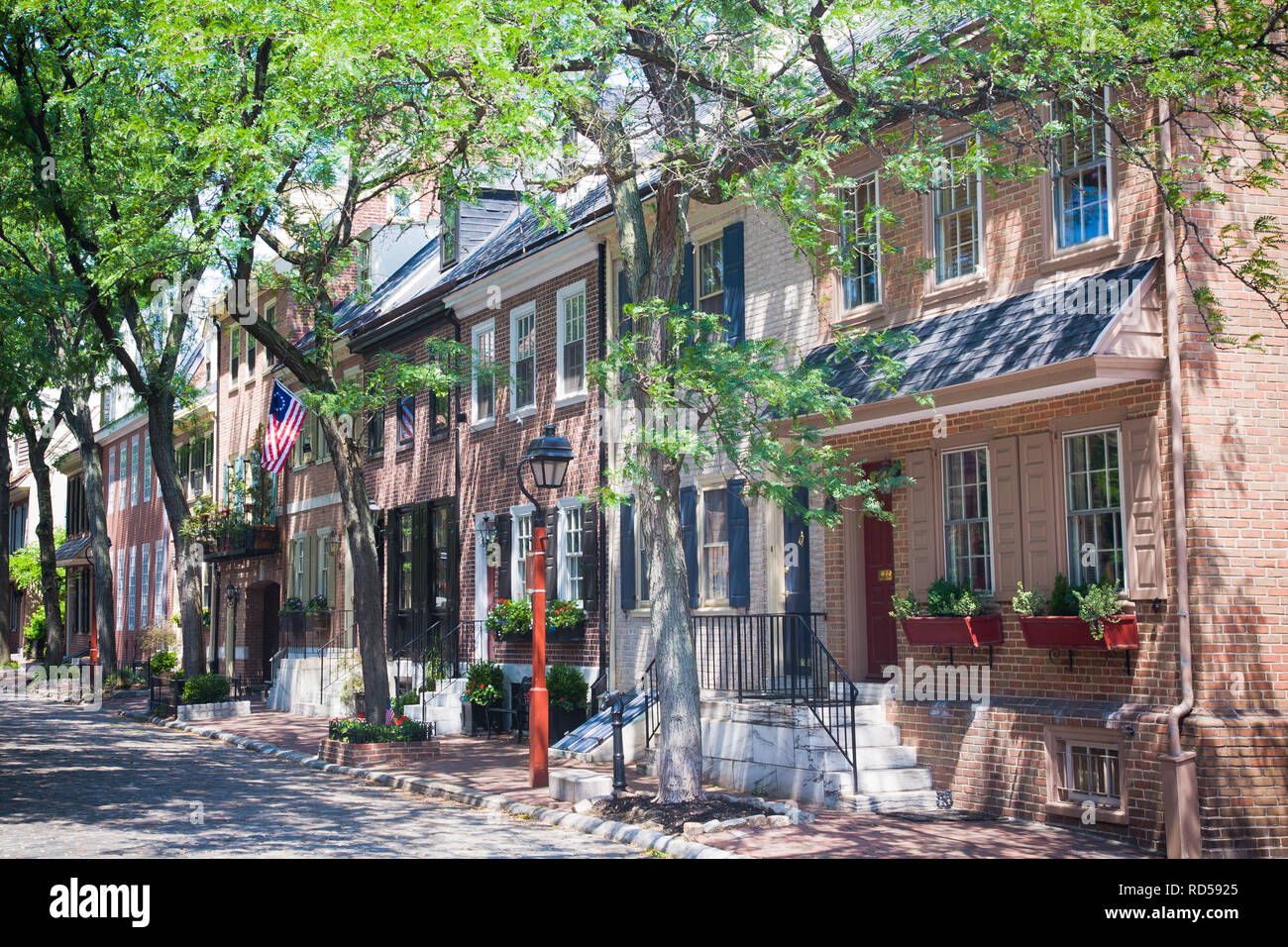 Row of townhouses in Philadelphia, PA, USA. The tree lined street is an ...