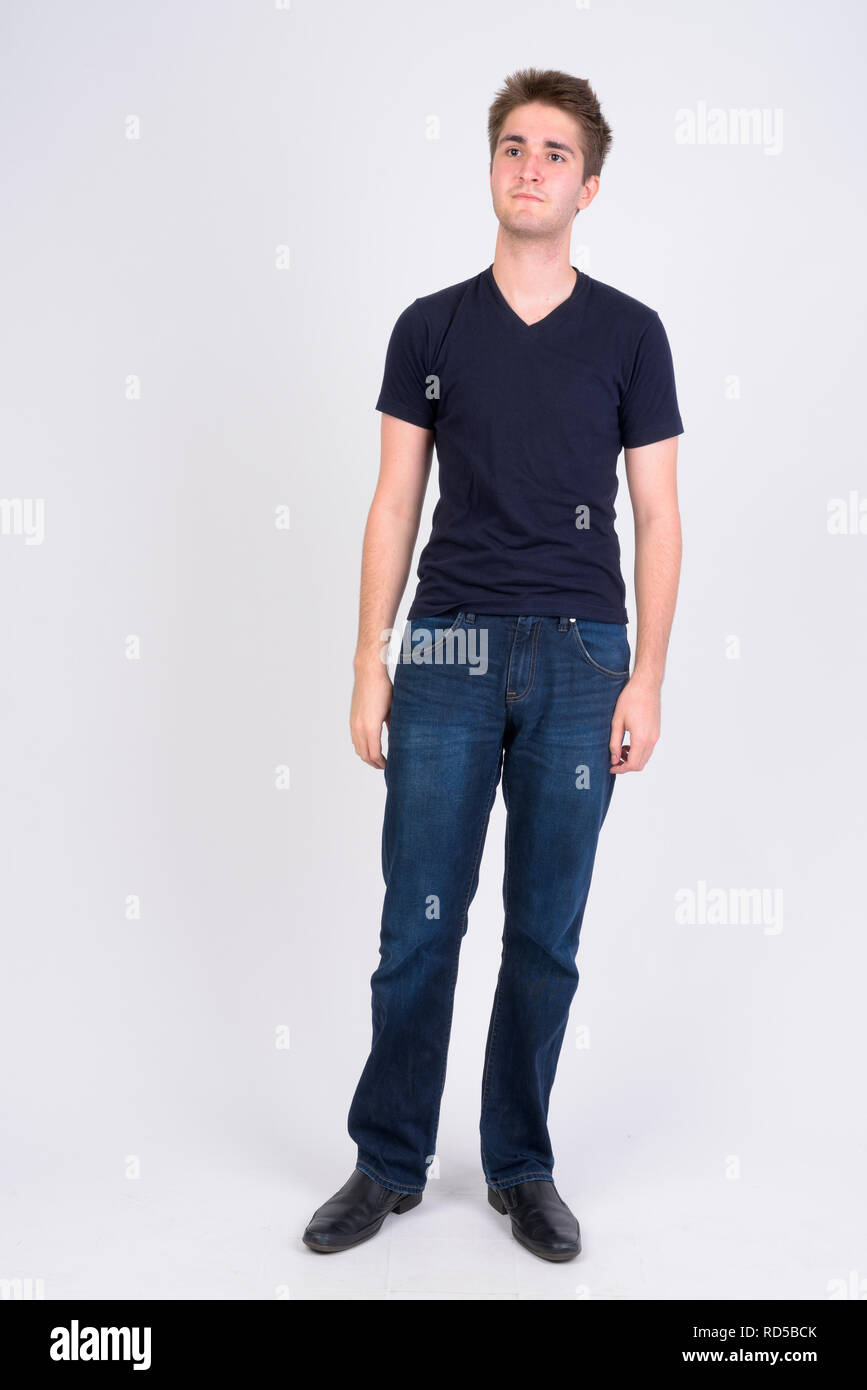 Full body shot of young handsome man thinking Stock Photo - Alamy