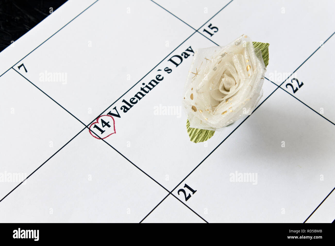 Calendar page with flower on February 14, Valentine's Day on a black ...