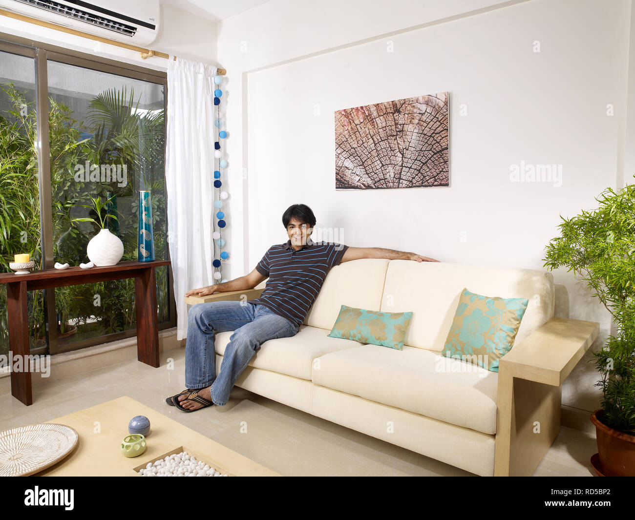 PORTRAIT OF A YOUNG MAN RELAXING IN HIS HOME Stock Photo - Alamy
