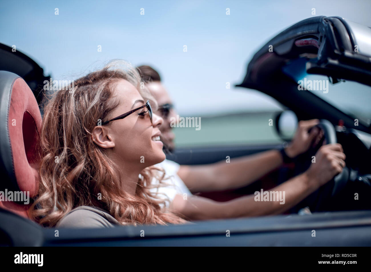 Affectionate couple sitting in convertible hi-res stock photography and ...