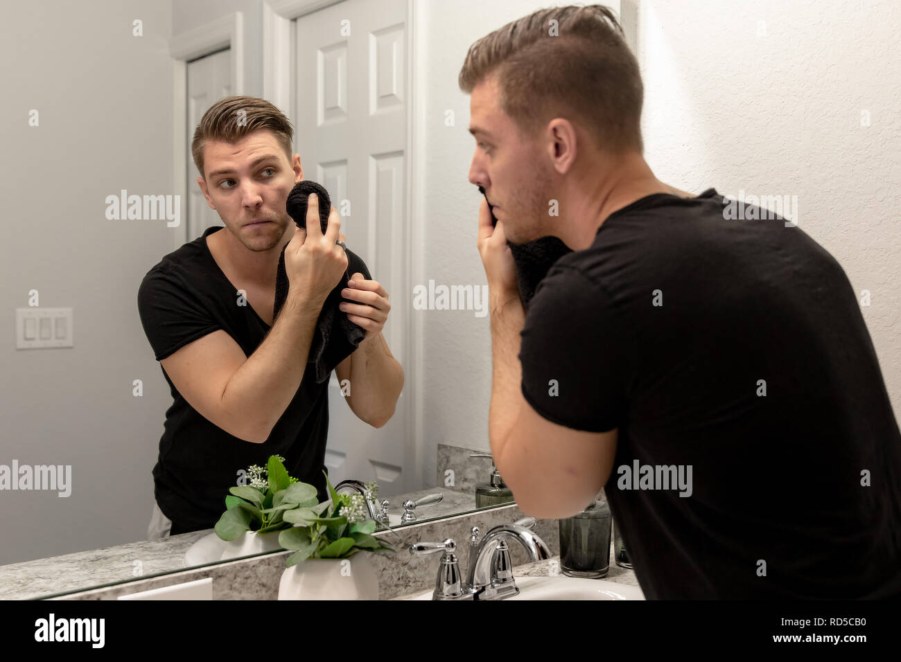 Good Looking Young Man Washing Hands and Face in Home Bathroom Mirror ...