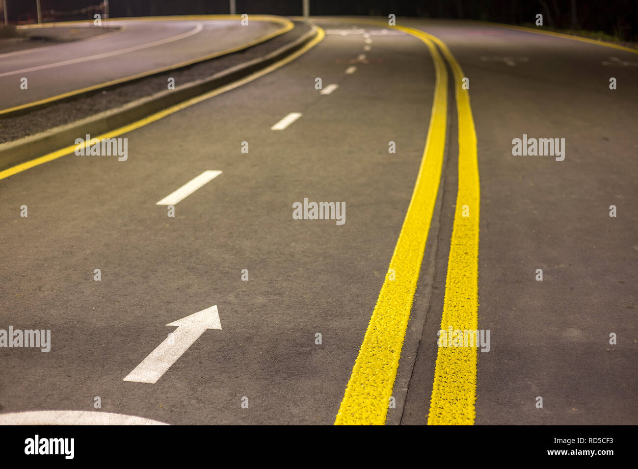 Wide bright yellow street marking sign line along modern wide smooth ...