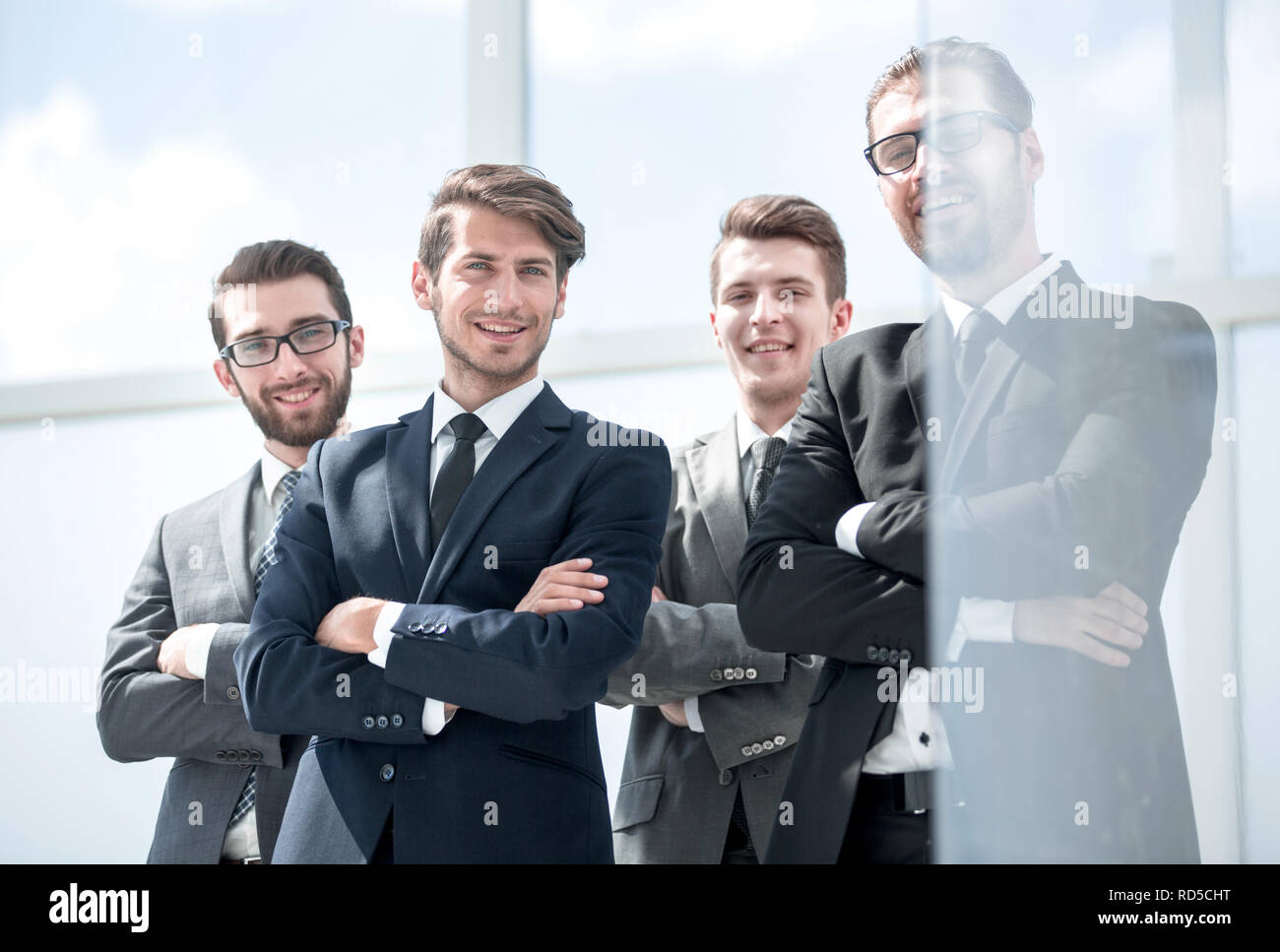 smiling employees standing together Stock Photo - Alamy