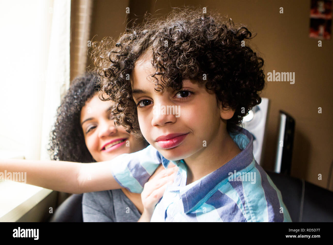 Close up of autistic ethnic boy smiles with mother hi-res stock ...