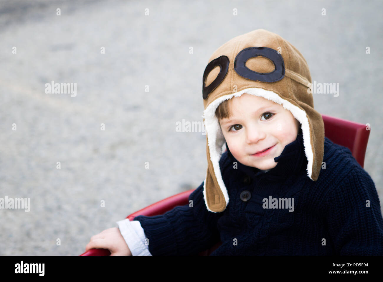 toddler caucasian boy wears a red baron hat outside Stock Photo - Alamy