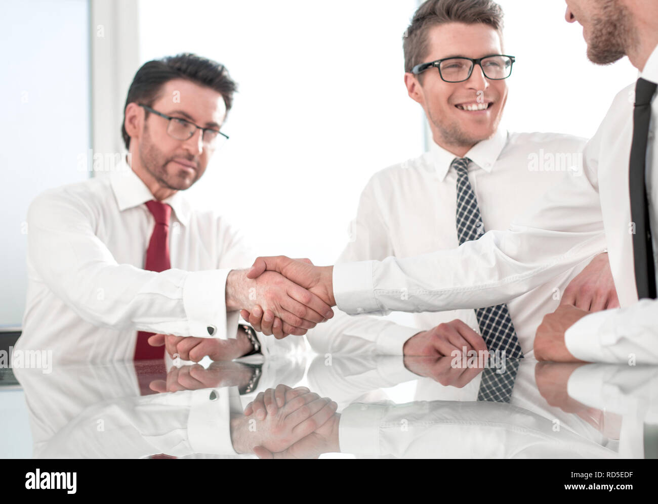 employees greet each other with a handshake Stock Photo - Alamy