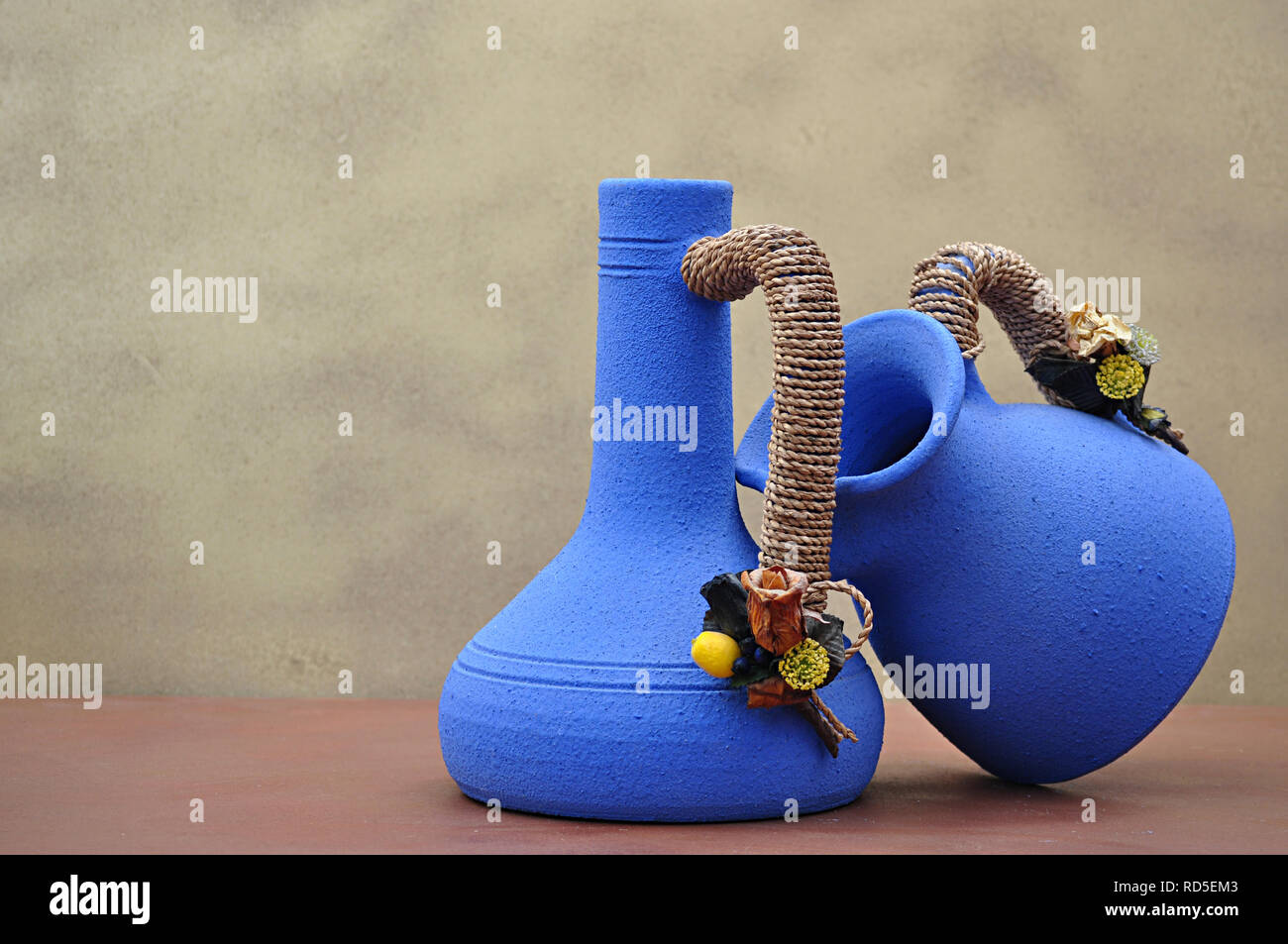 Fancy ceramic vases in blue and adorned with rope Stock Photo - Alamy