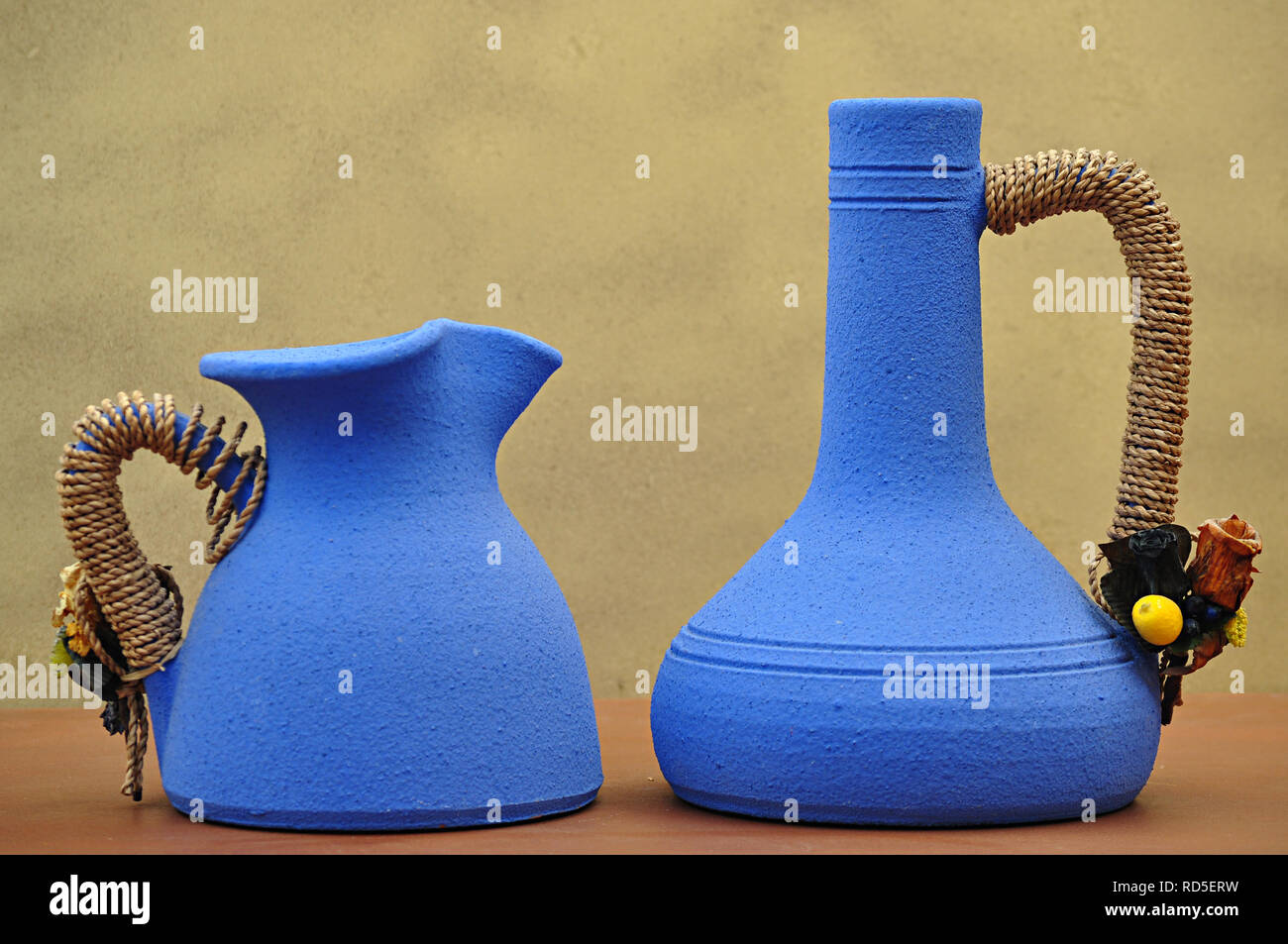 Fancy ceramic vases in blue and adorned with rope Stock Photo - Alamy