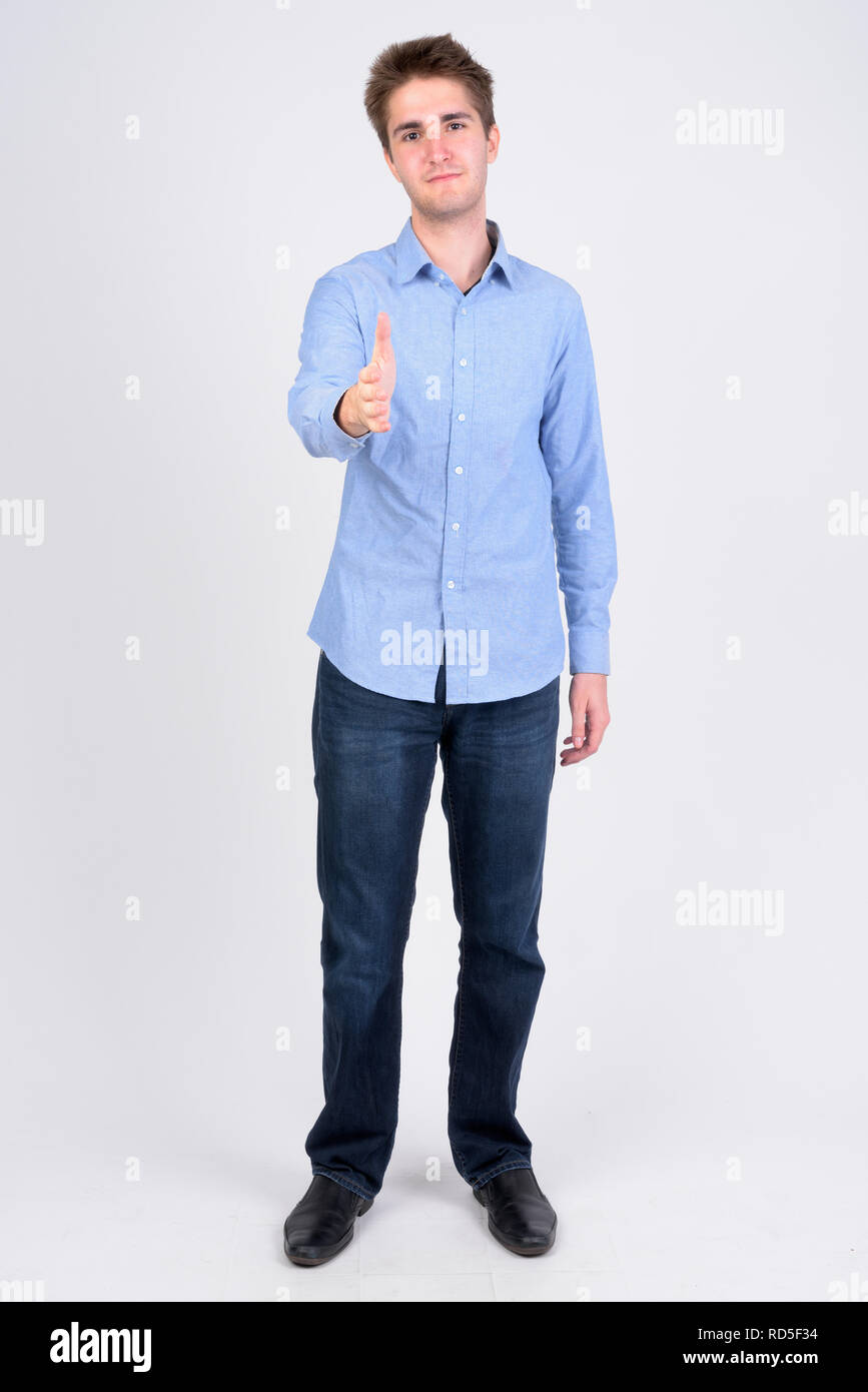 Full body shot of young handsome businessman giving handshake Stock ...