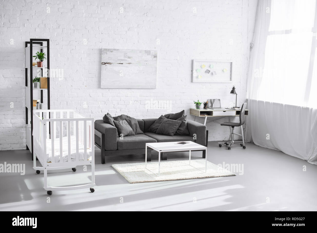 modern interior of living room with baby crib, sofa and workplace Stock ...