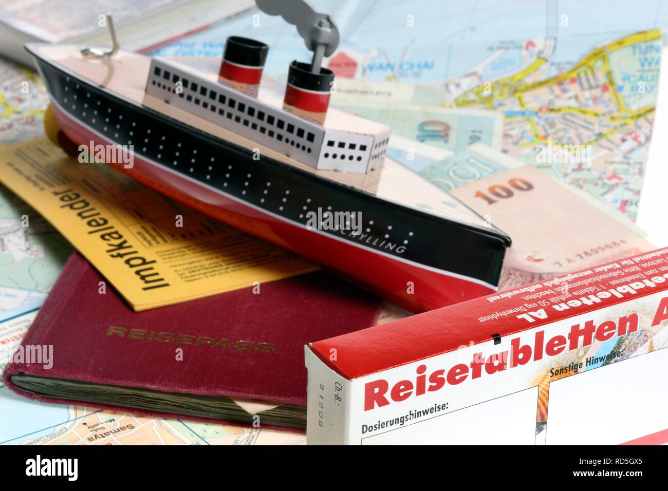 First-aid kit, vaccination card, miniature ship Stock Photo - Alamy