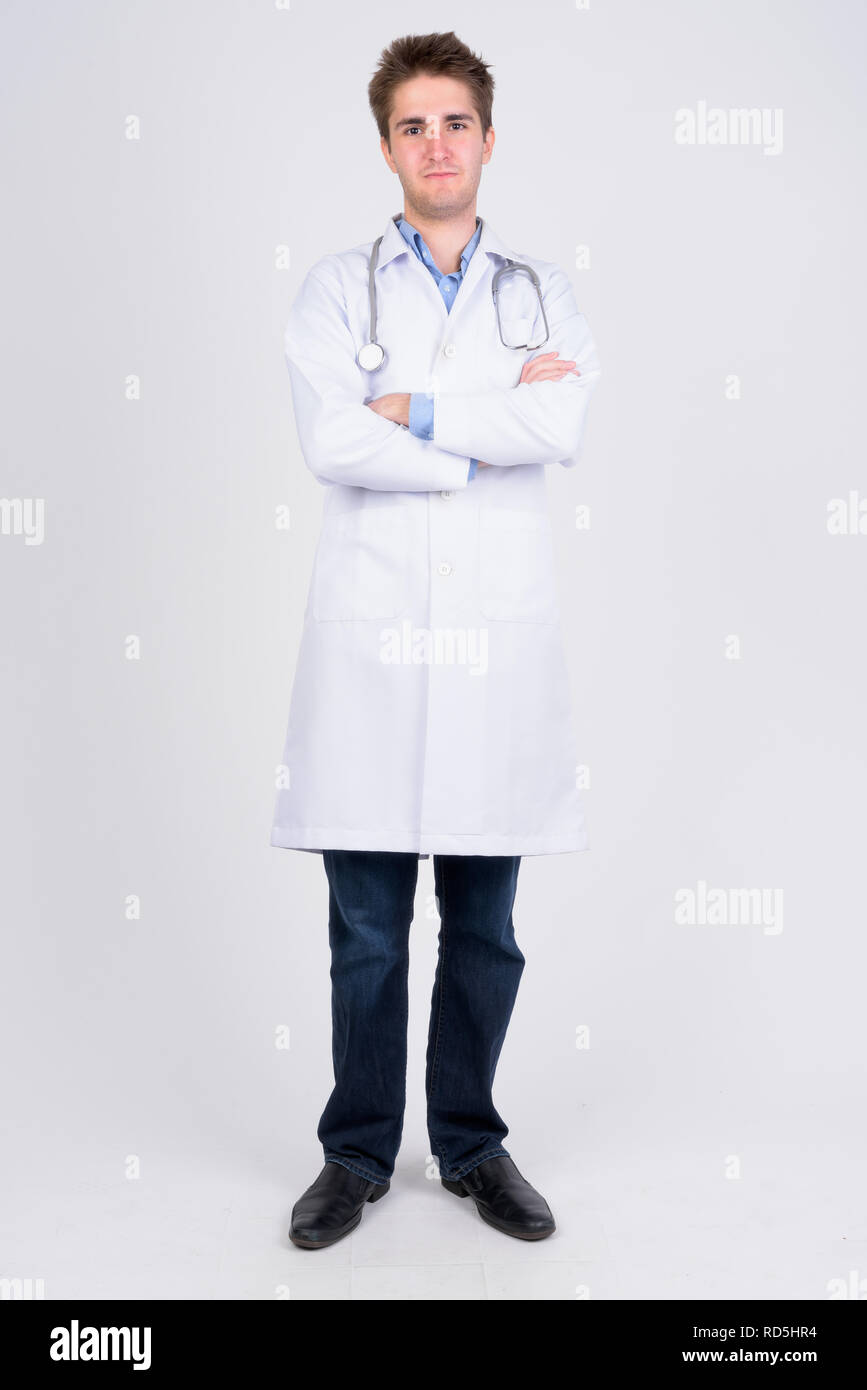 Full body shot of young handsome man doctor with arms crossed Stock ...