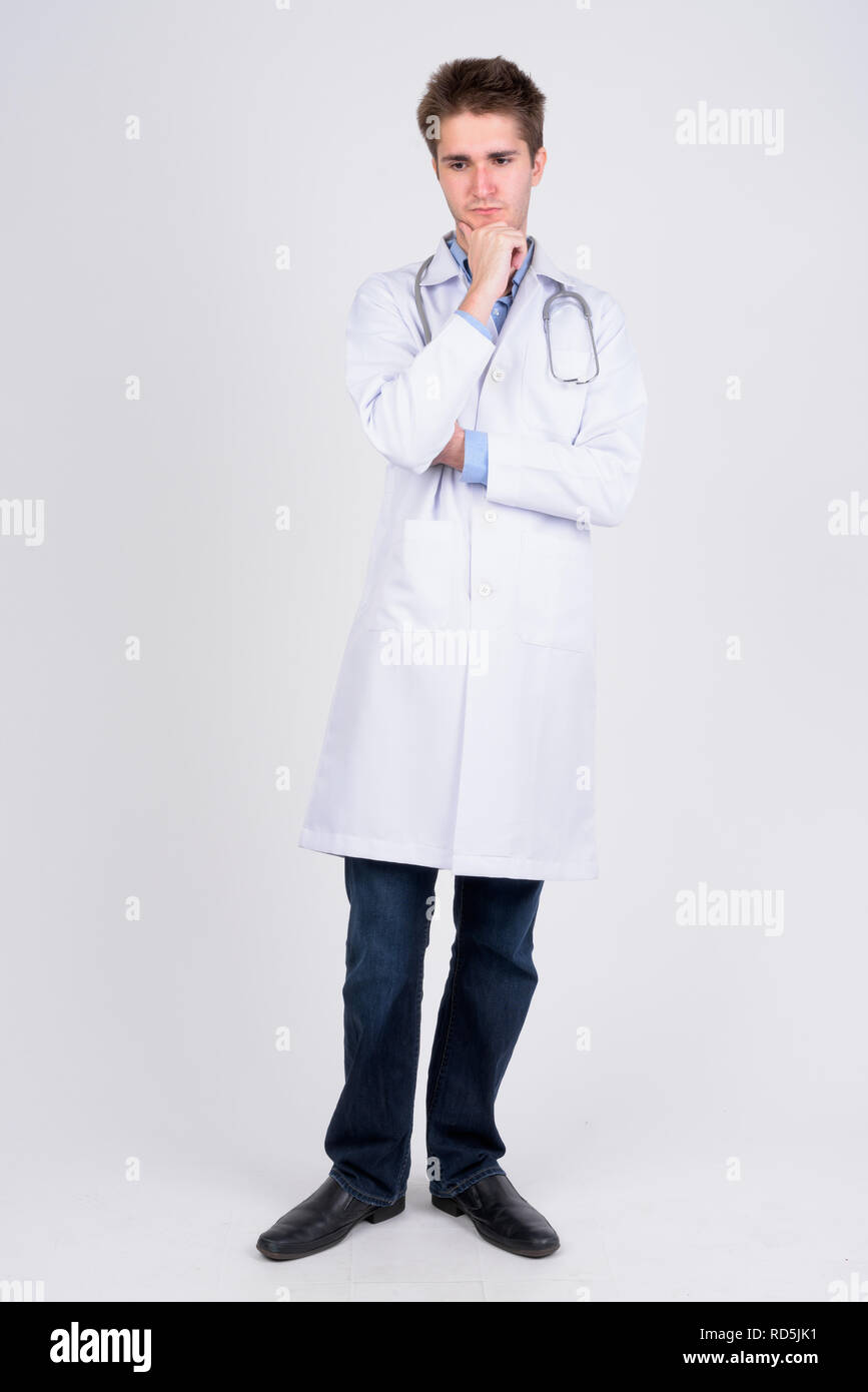 Full body shot of serious young man doctor thinking Stock Photo - Alamy