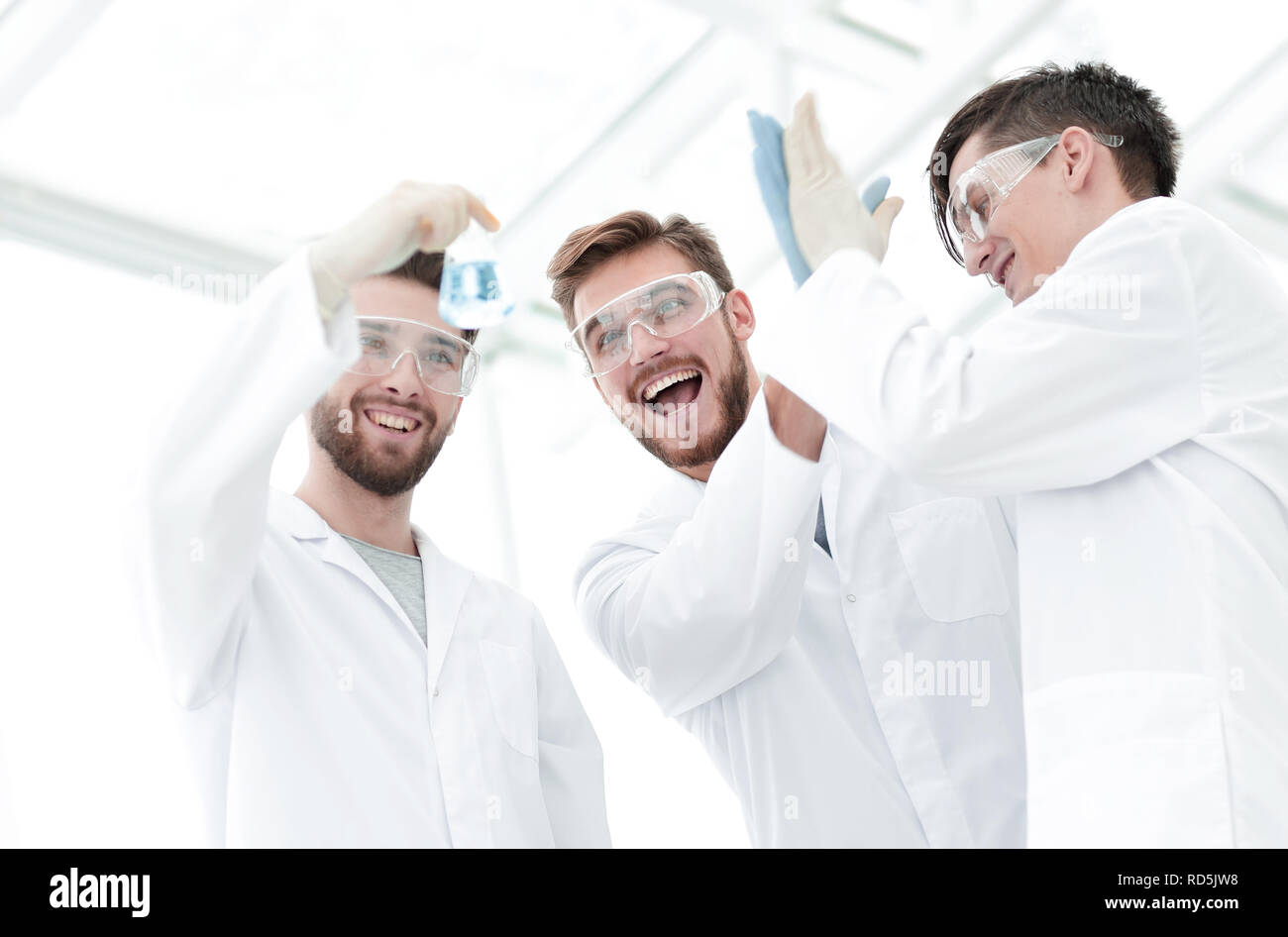 happy scientists look at the result of their work Stock Photo - Alamy