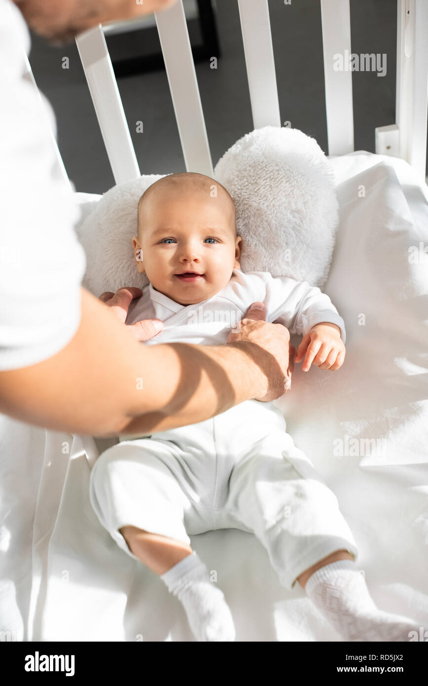 Baby in crib father hi-res stock photography and images - Alamy