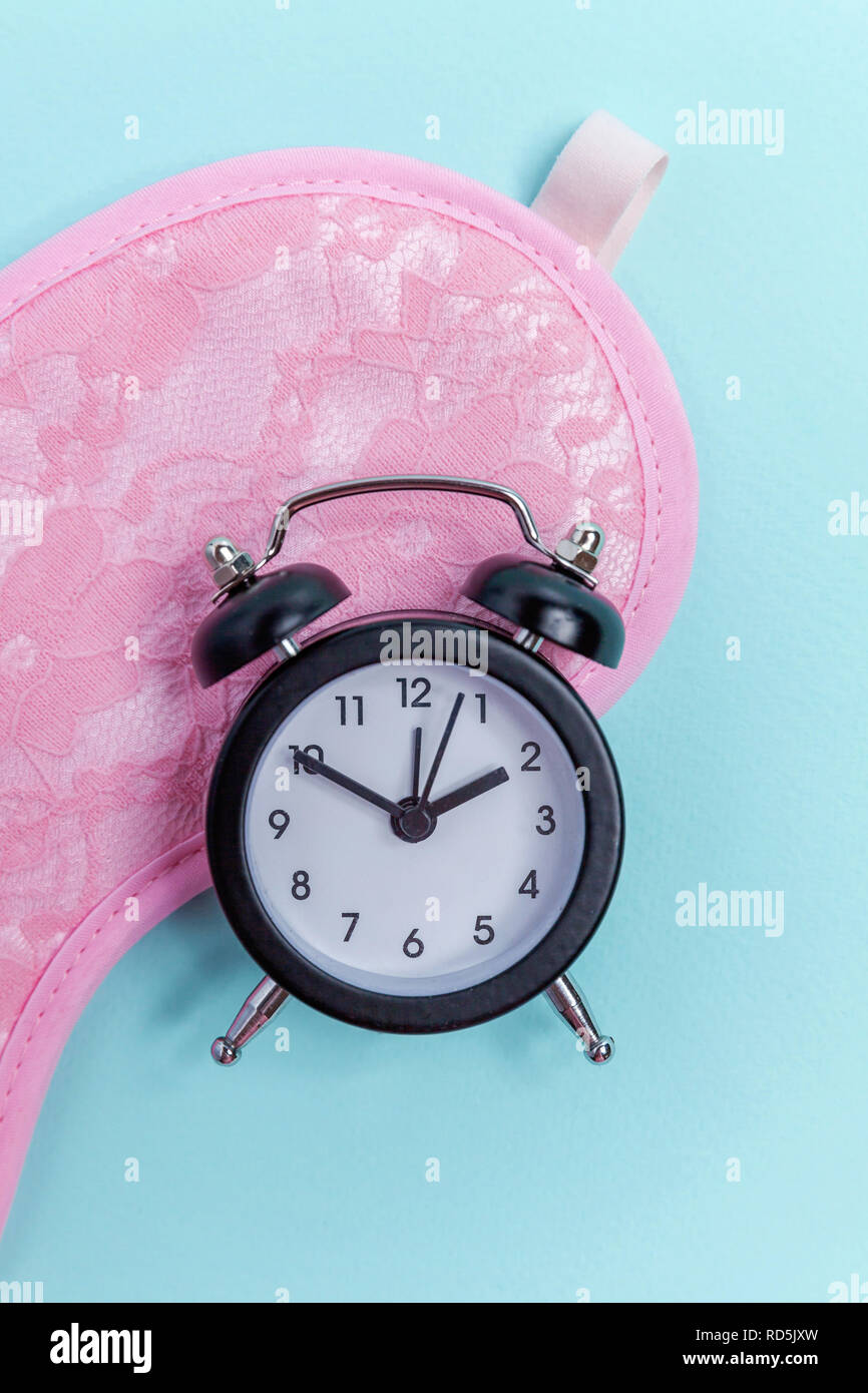 Sleeping eye mask, alarm clock isolated on blue pastel colourful trendy ...