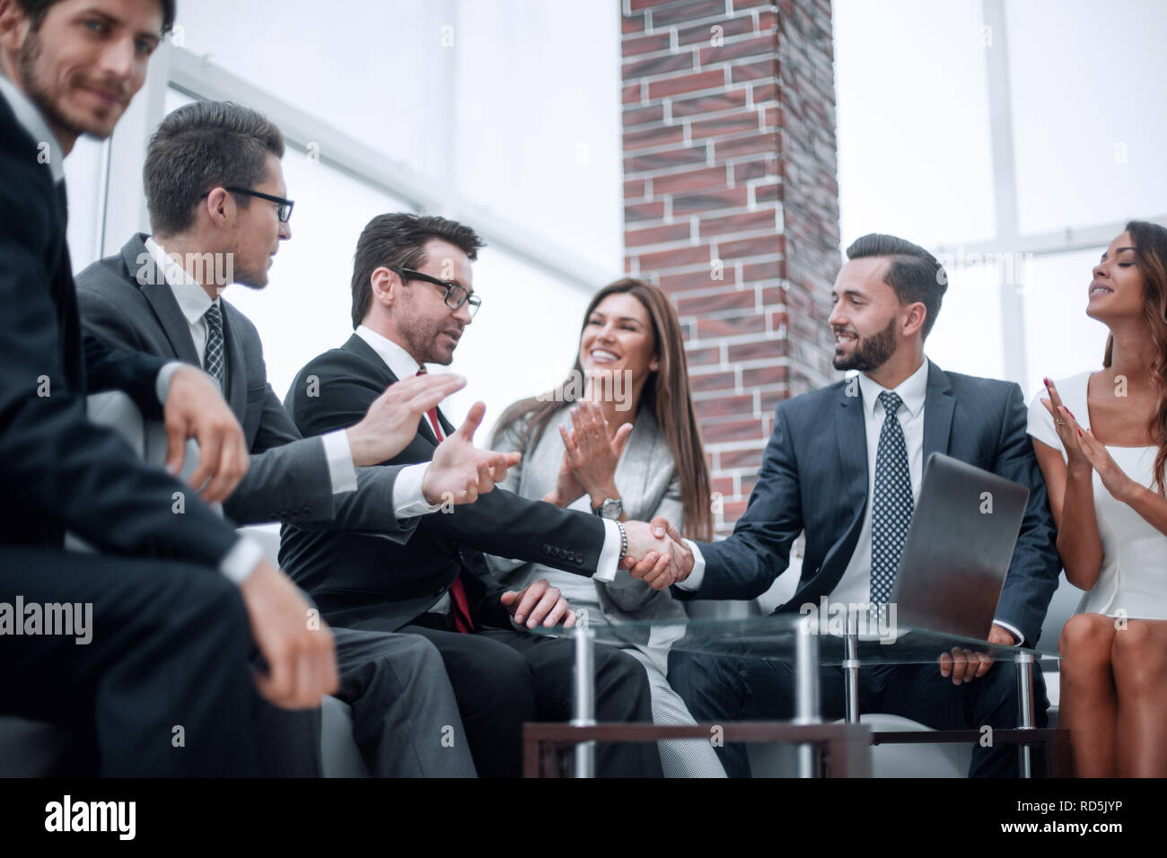 Business colleagues shaking hands couch hi-res stock photography and ...