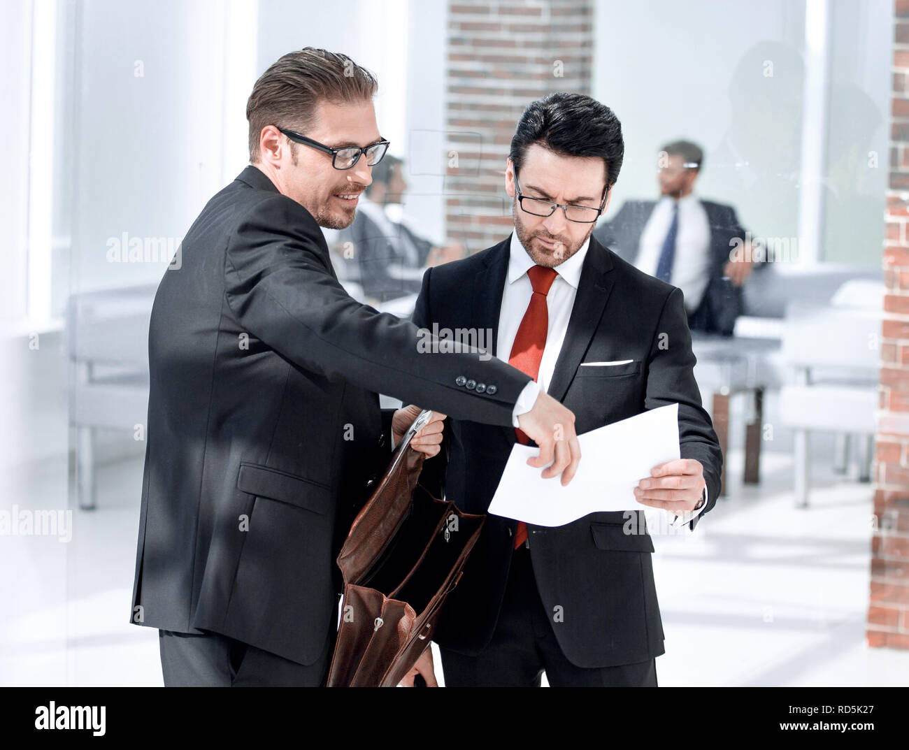 business men with documents in a large conference room Stock Photo - Alamy