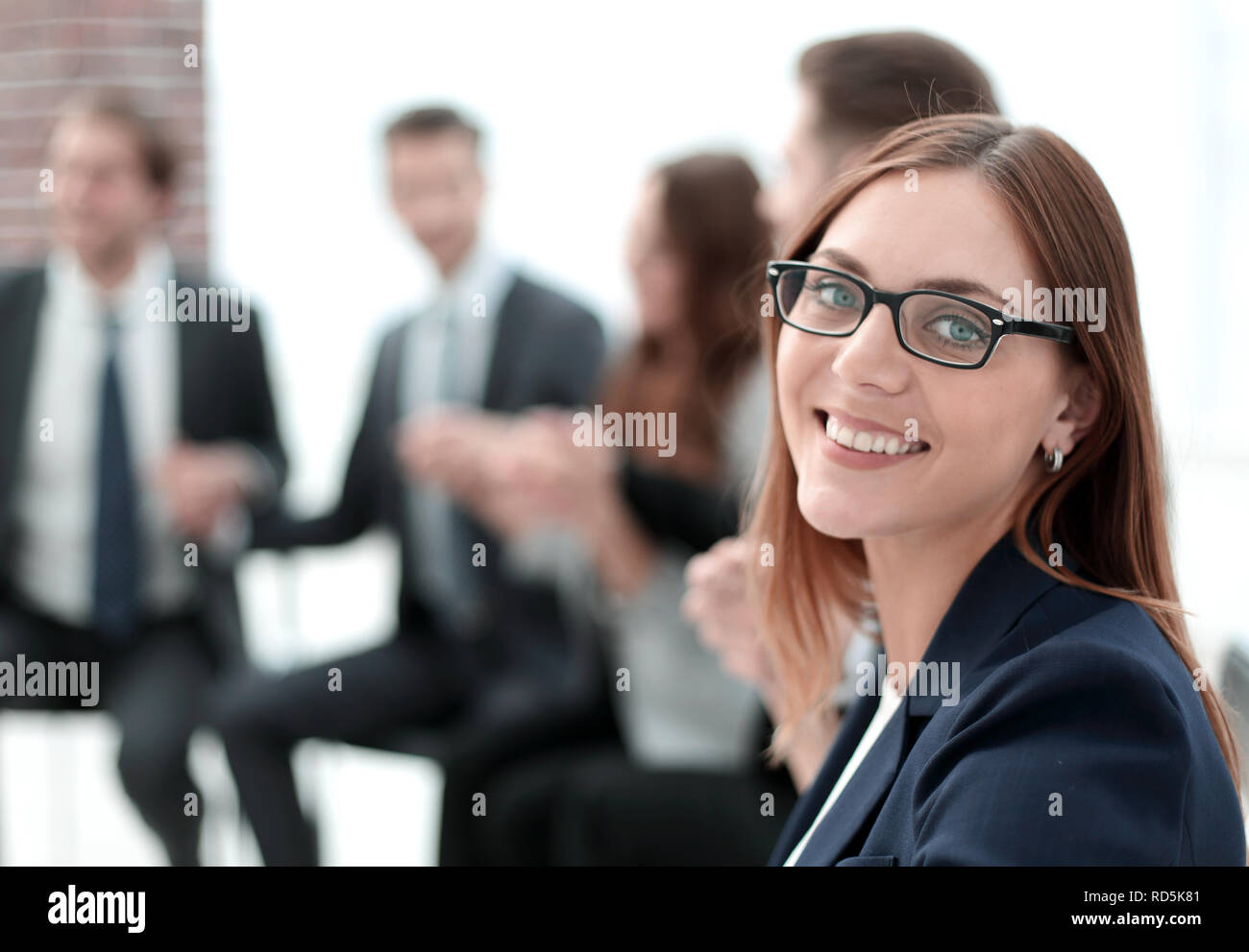 Attractive office worker standing Stock Photo - Alamy
