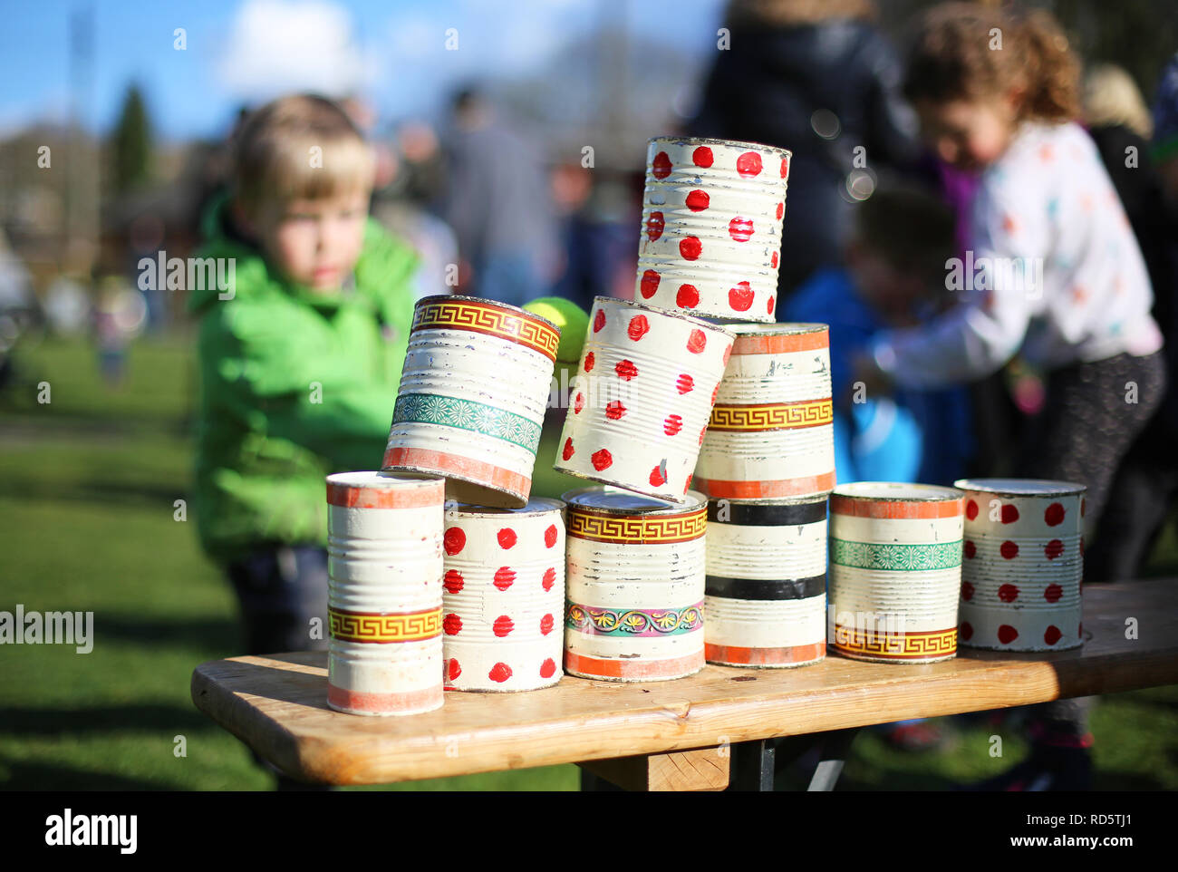 children playing can knockdown Stock Photo - Alamy