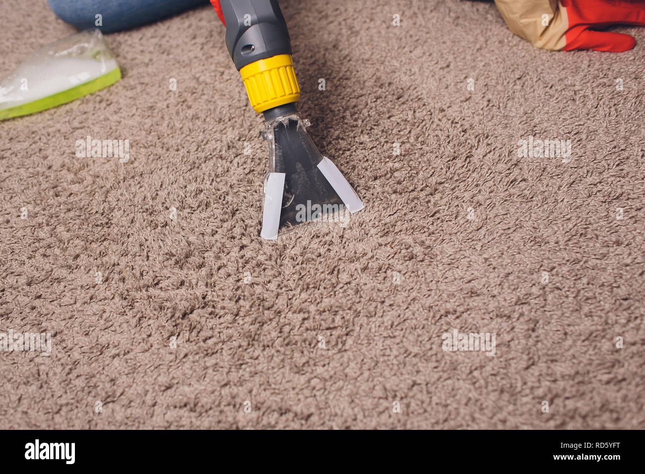 Woman removing dirt from carpet with vacuum cleaner in room Stock Photo ...