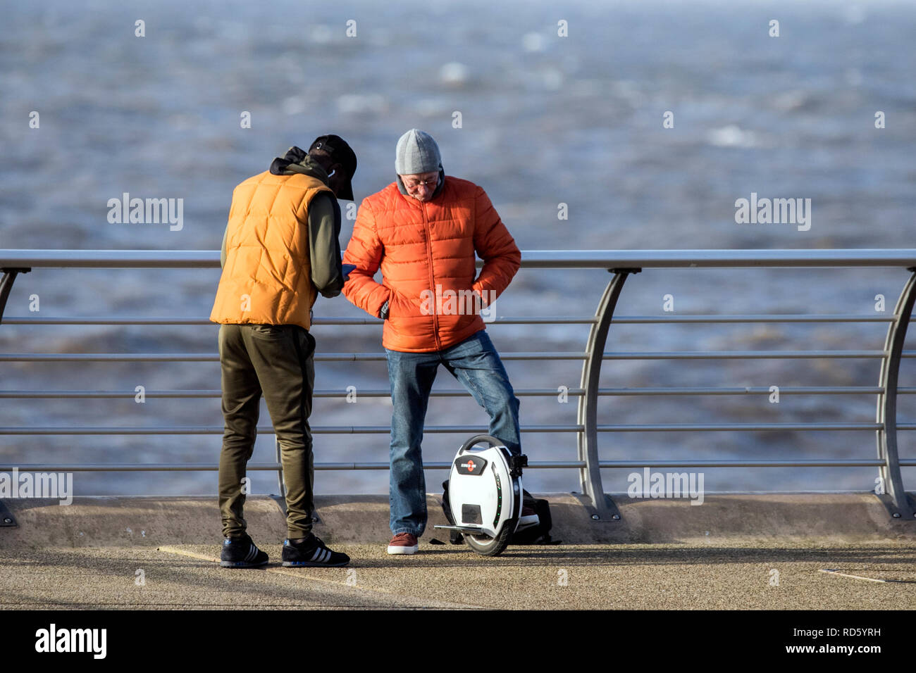 A man rides his self balancing unicycle gyro scooter along the ...