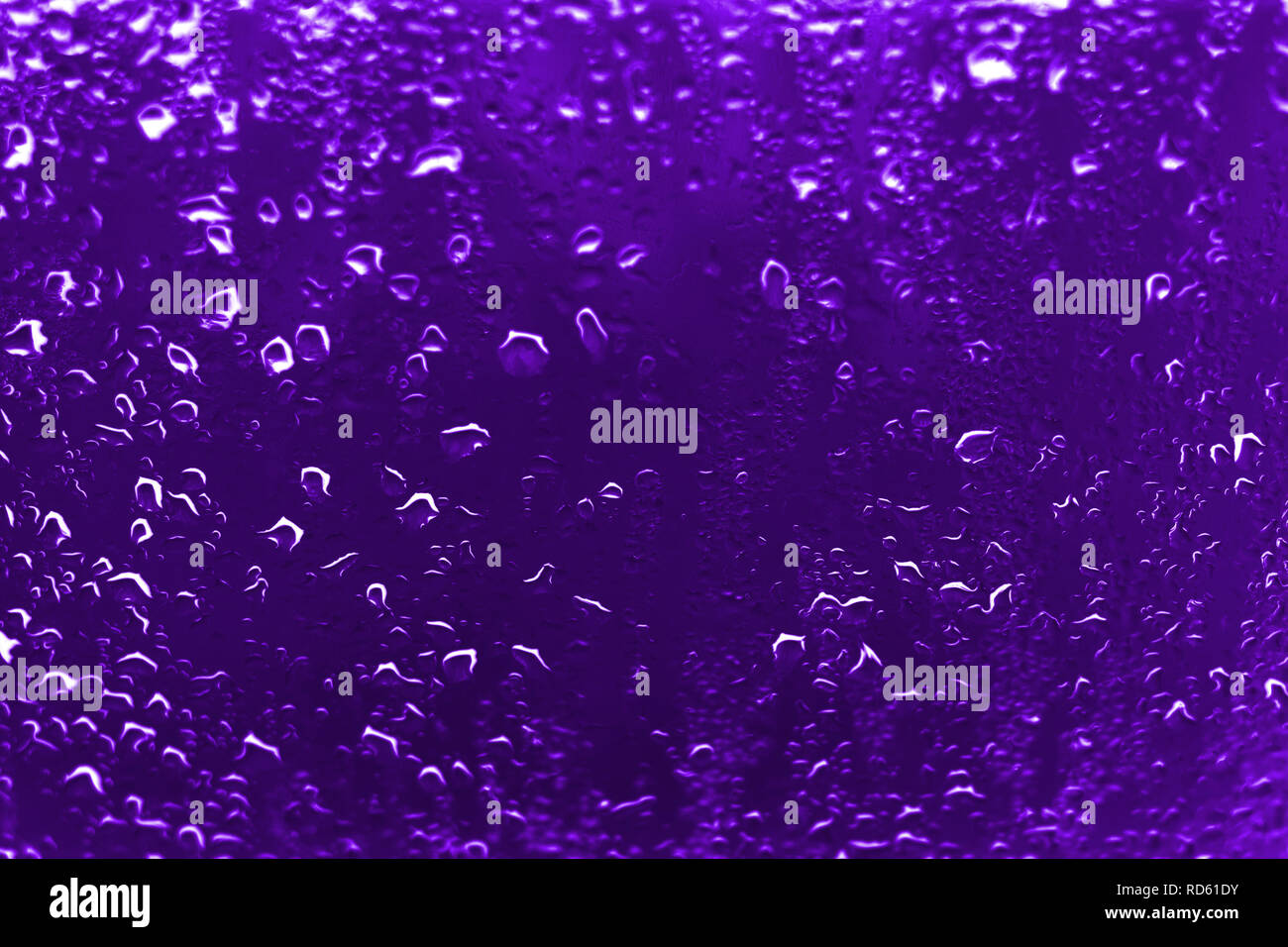 High contrast photo of drops of rain on a window glass with vivid ...