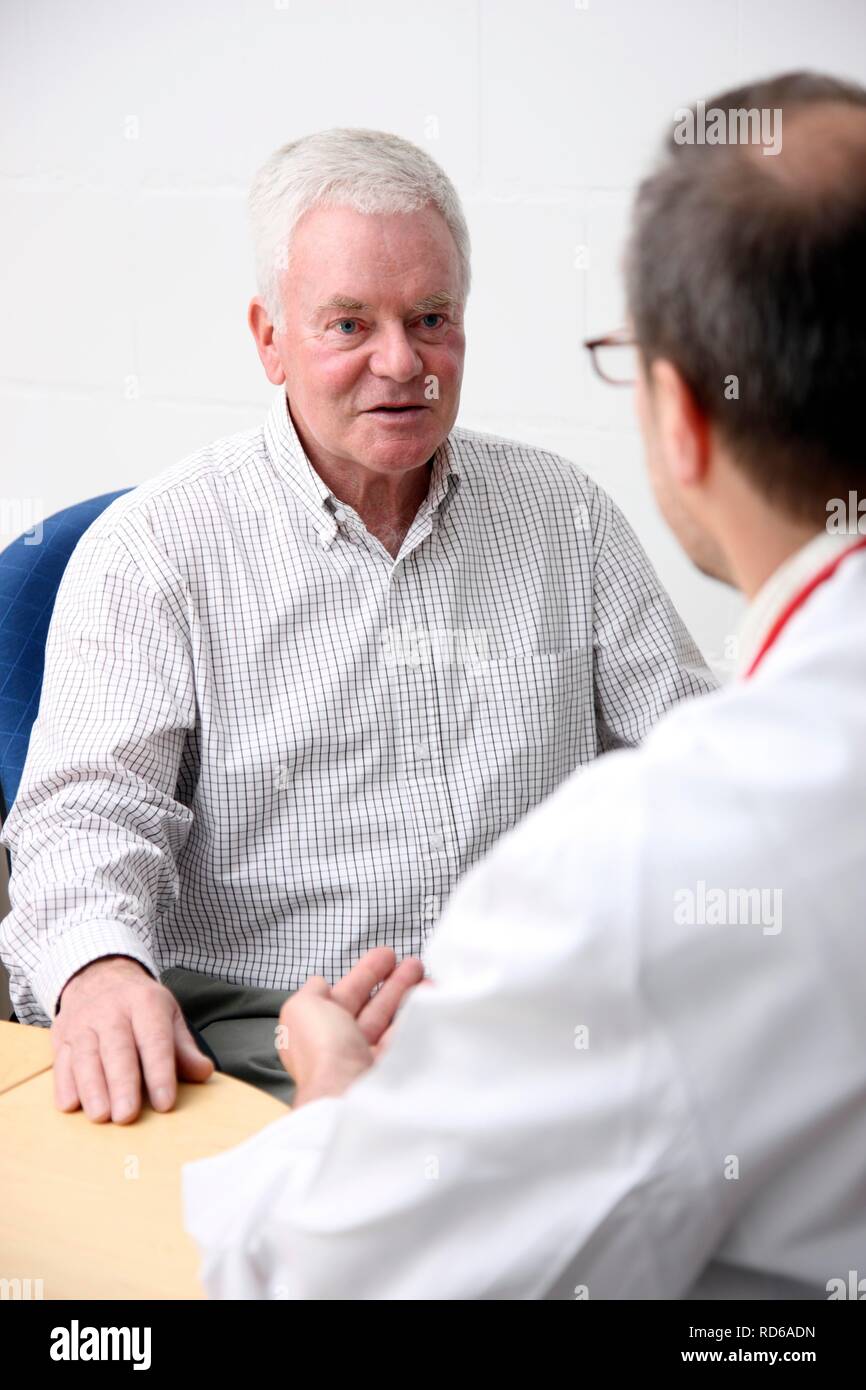 Man, senior, about 70 years old, having a conversation with his doctor ...