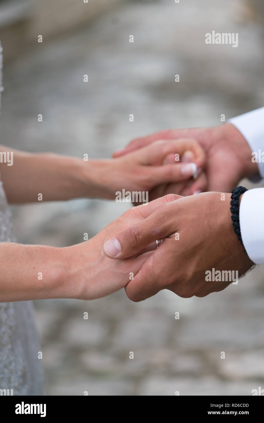 Wedding couple holding hands Stock Photo - Alamy