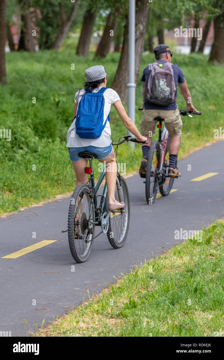 Man woman cycling together road hi-res stock photography and images - Alamy