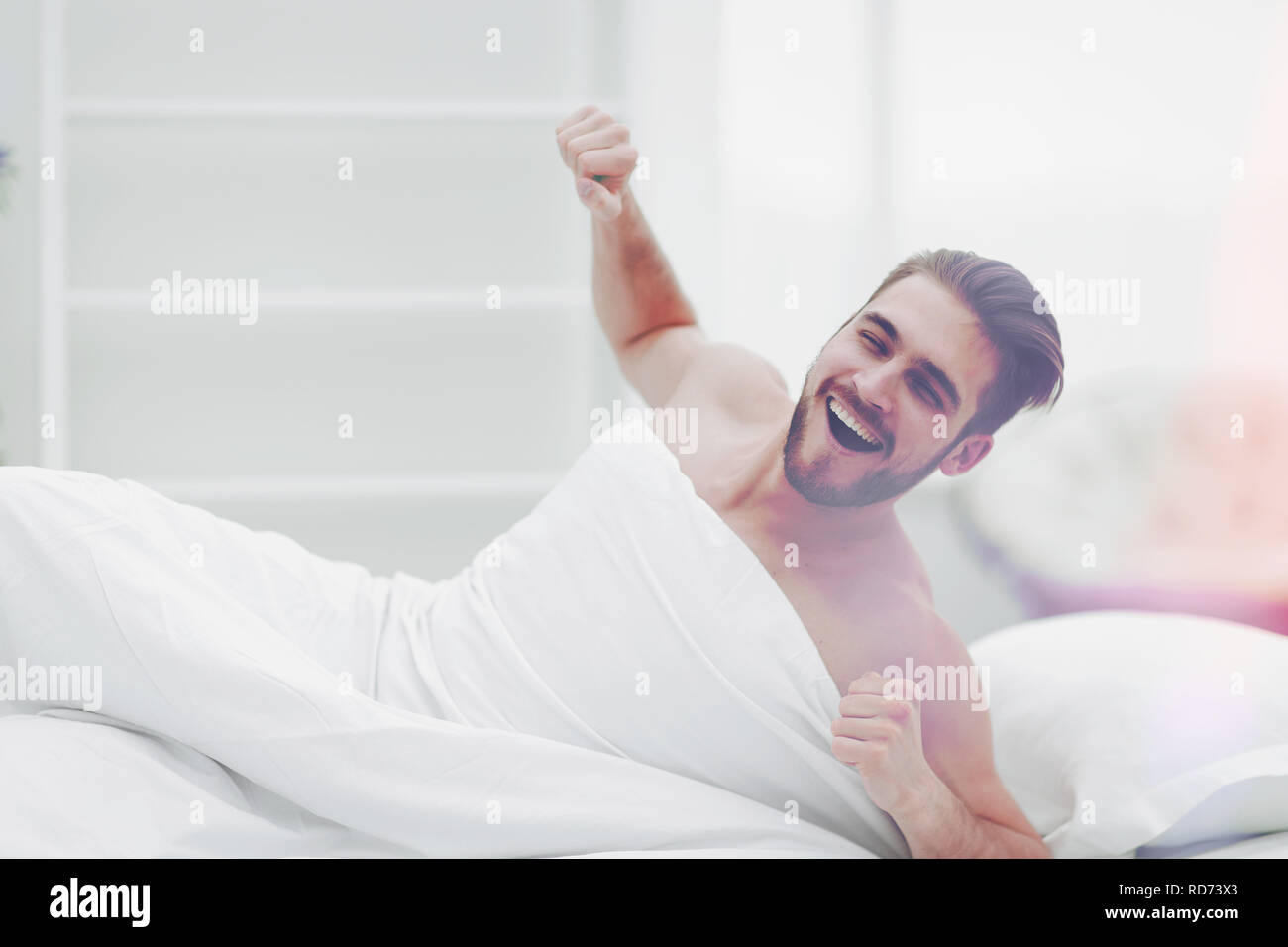 smiling man waking up in the morning Stock Photo - Alamy