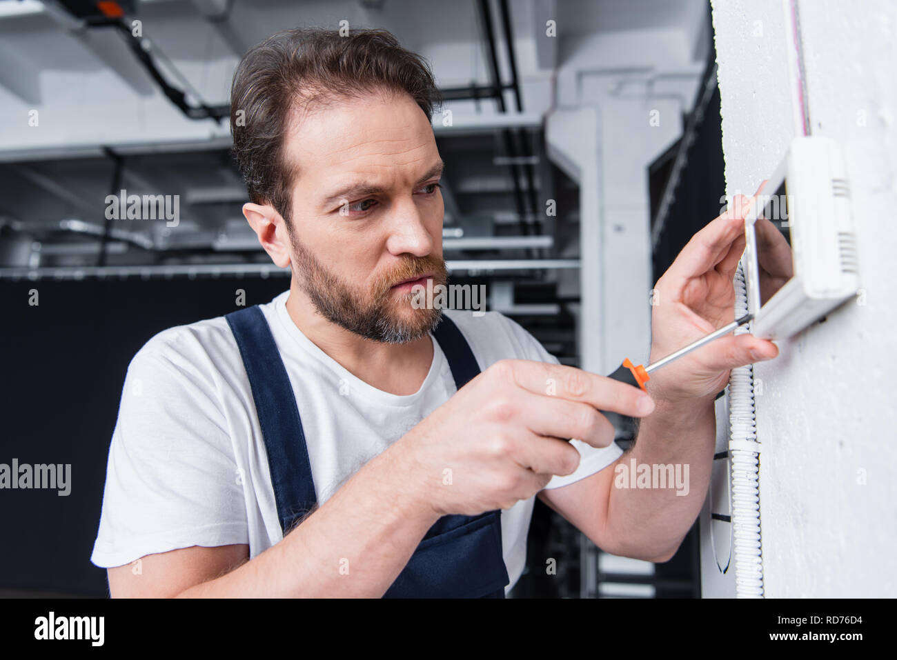 adult male craftsman fixing electrical panel by screwdriver Stock Photo ...