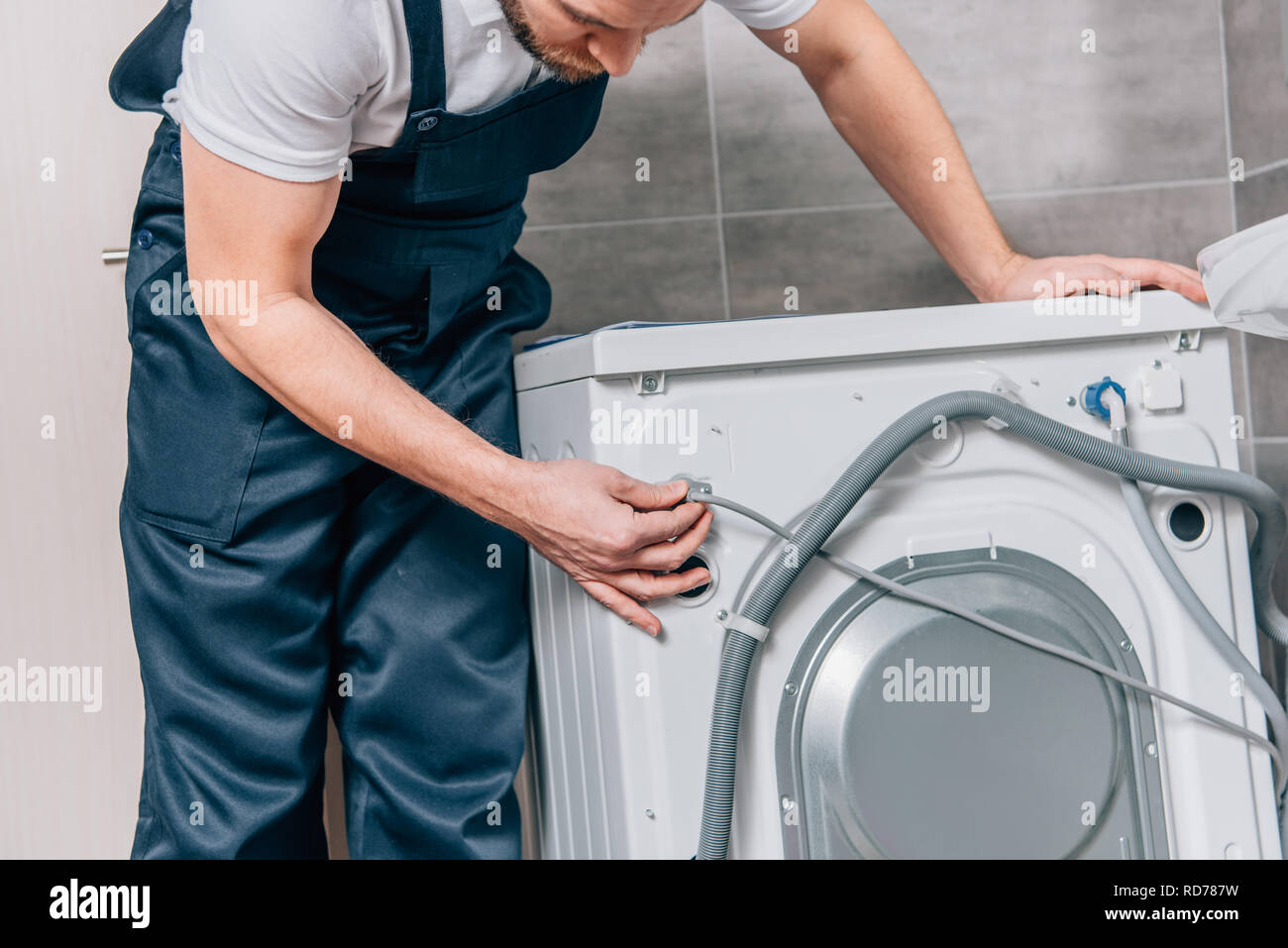Handyman repairing washing machine hi-res stock photography and images ...