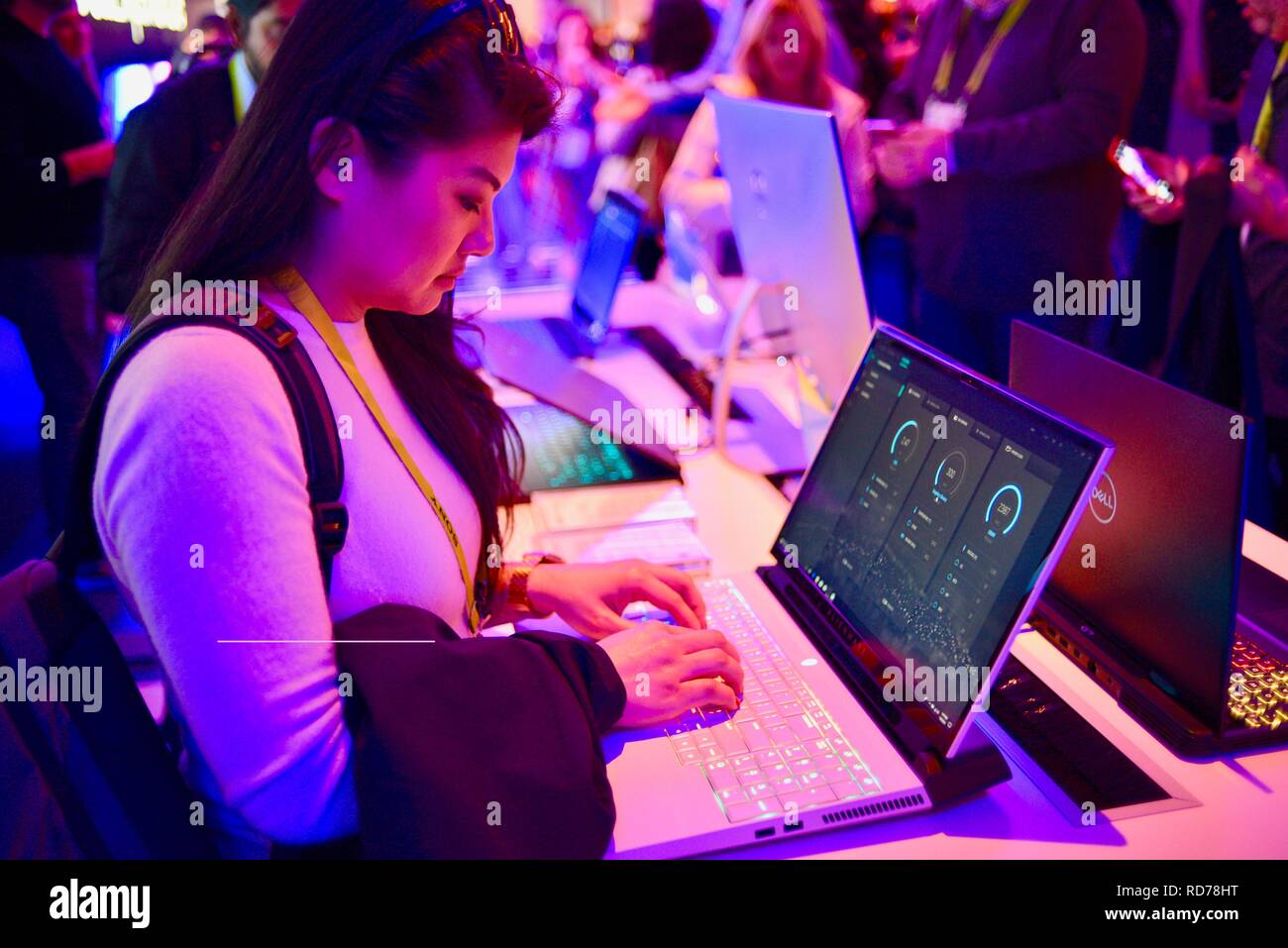 Female CES attendee at Dell booth, trying out recently launched ...