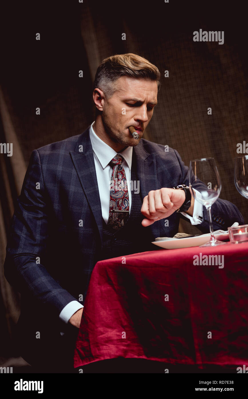 Man in suit smoking cigar hi-res stock photography and images - Alamy