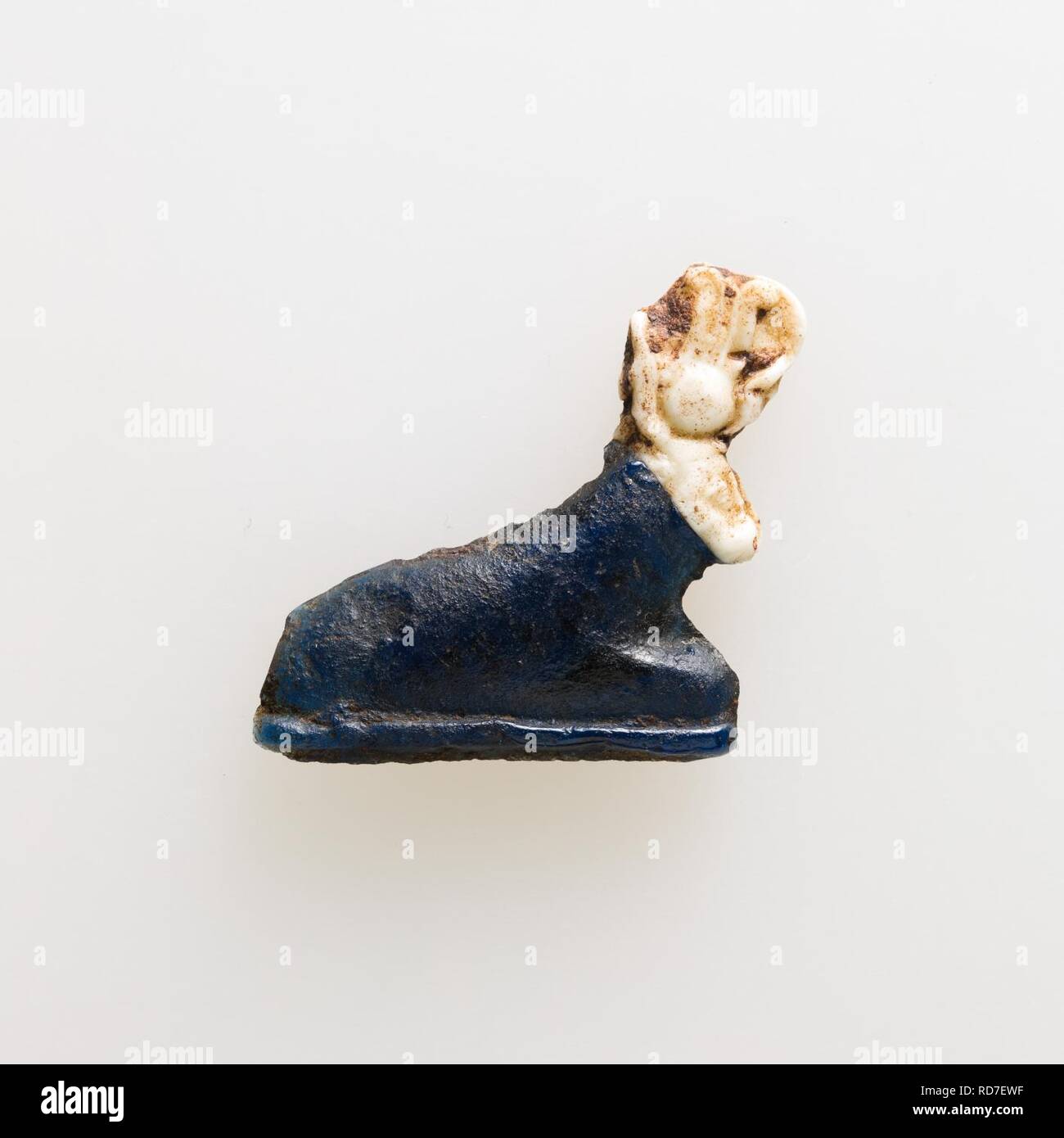 Amulet of kneeling cow wearing disk and feathers Stock Photo - Alamy