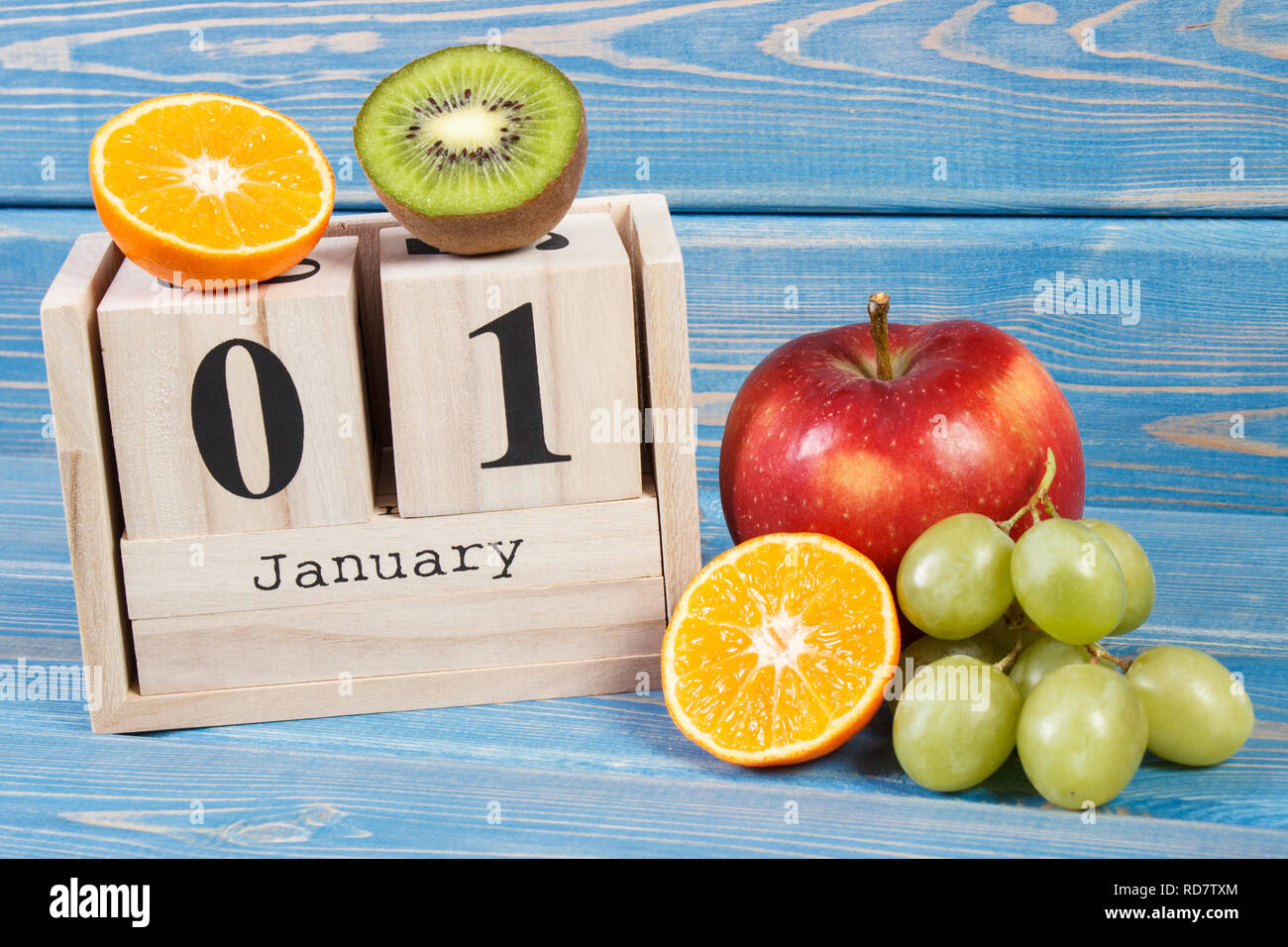 January 1 on cube calendar and fresh fruits, new years resolutions of ...
