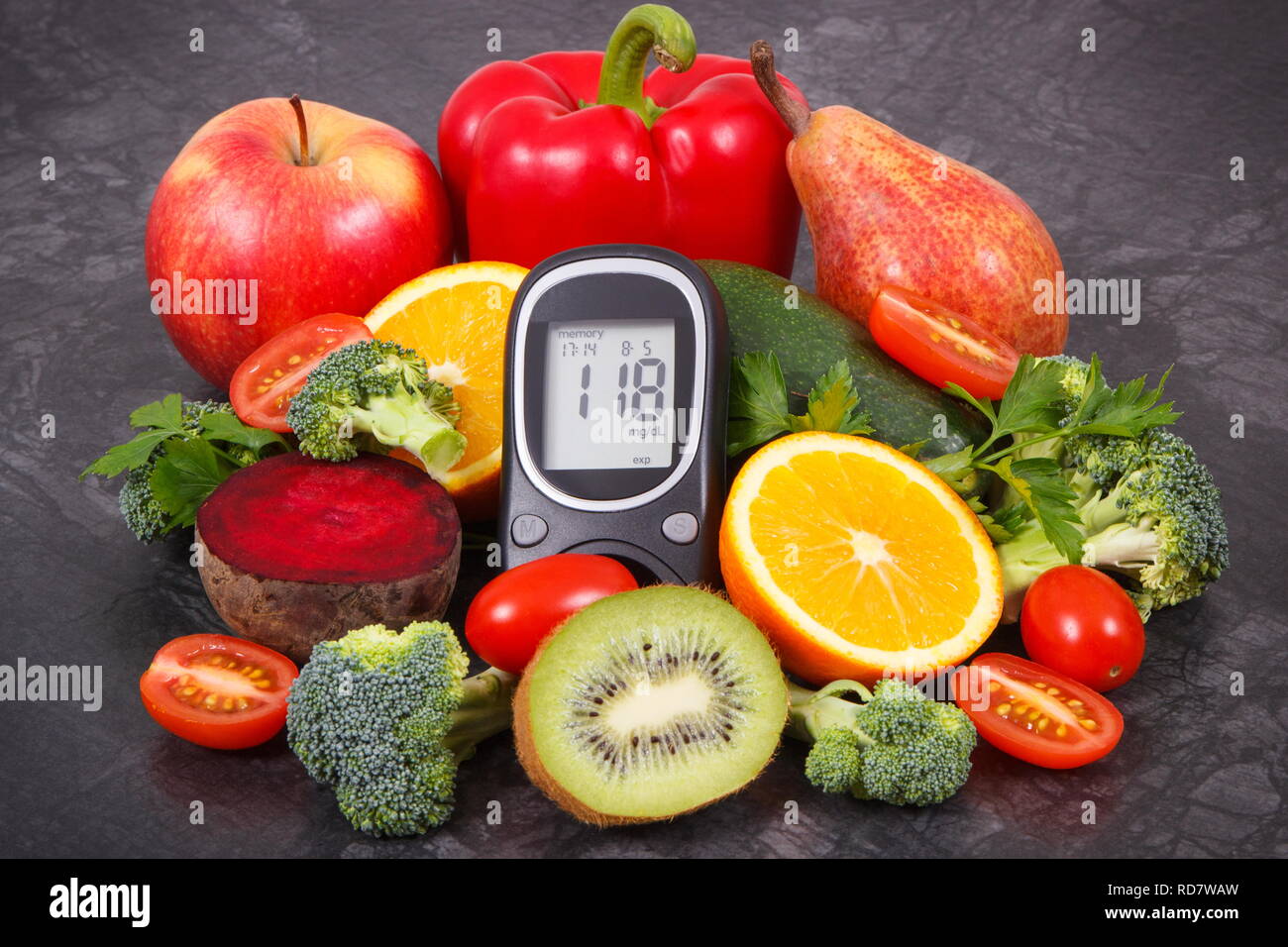 Glucometer for checking sugar level with fresh ripe fruits and ...