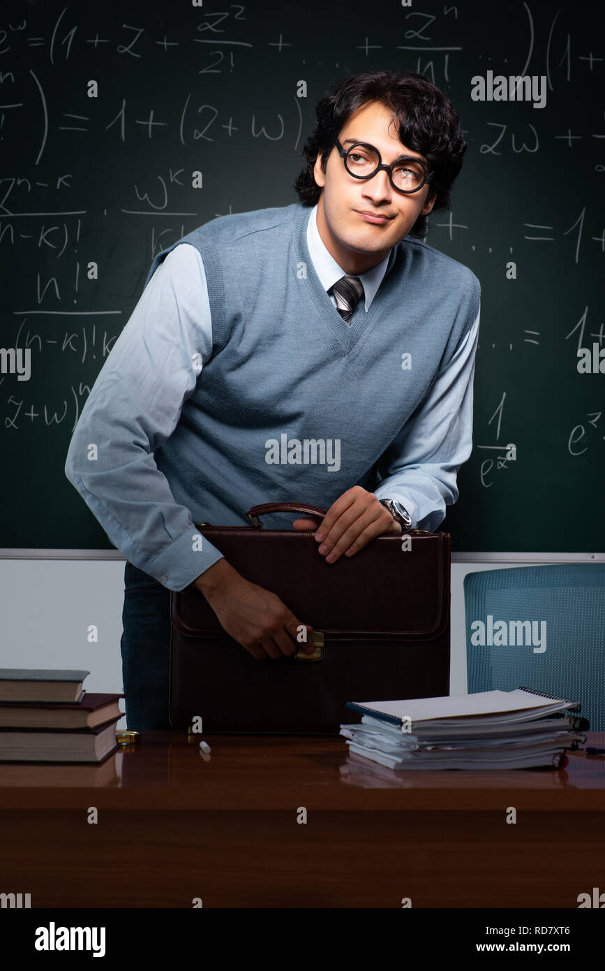 Young math teacher in front of chalkboard Stock Photo - Alamy