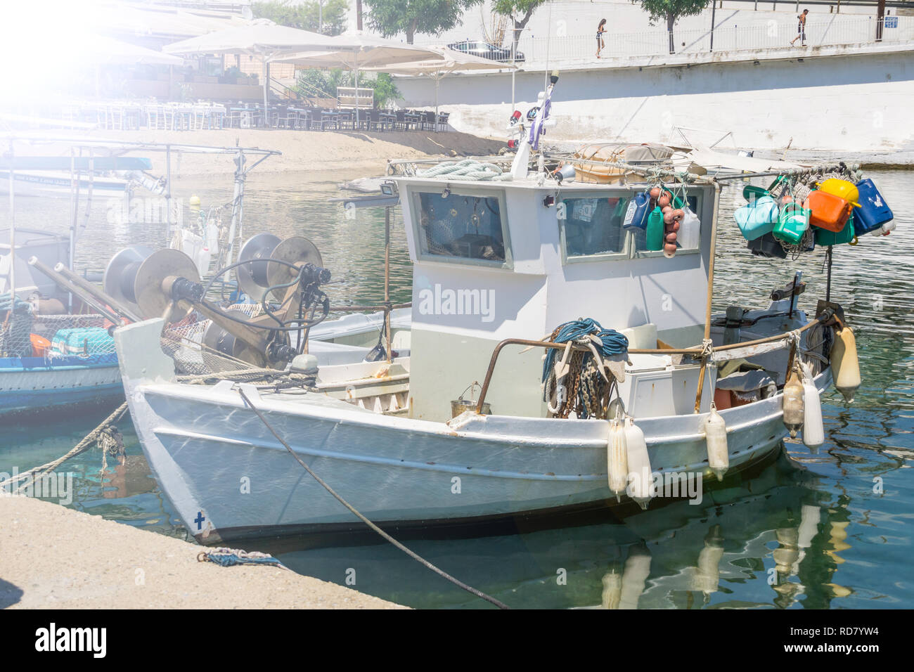White overloaded fishing boat anchored next to the dock in town Stock ...